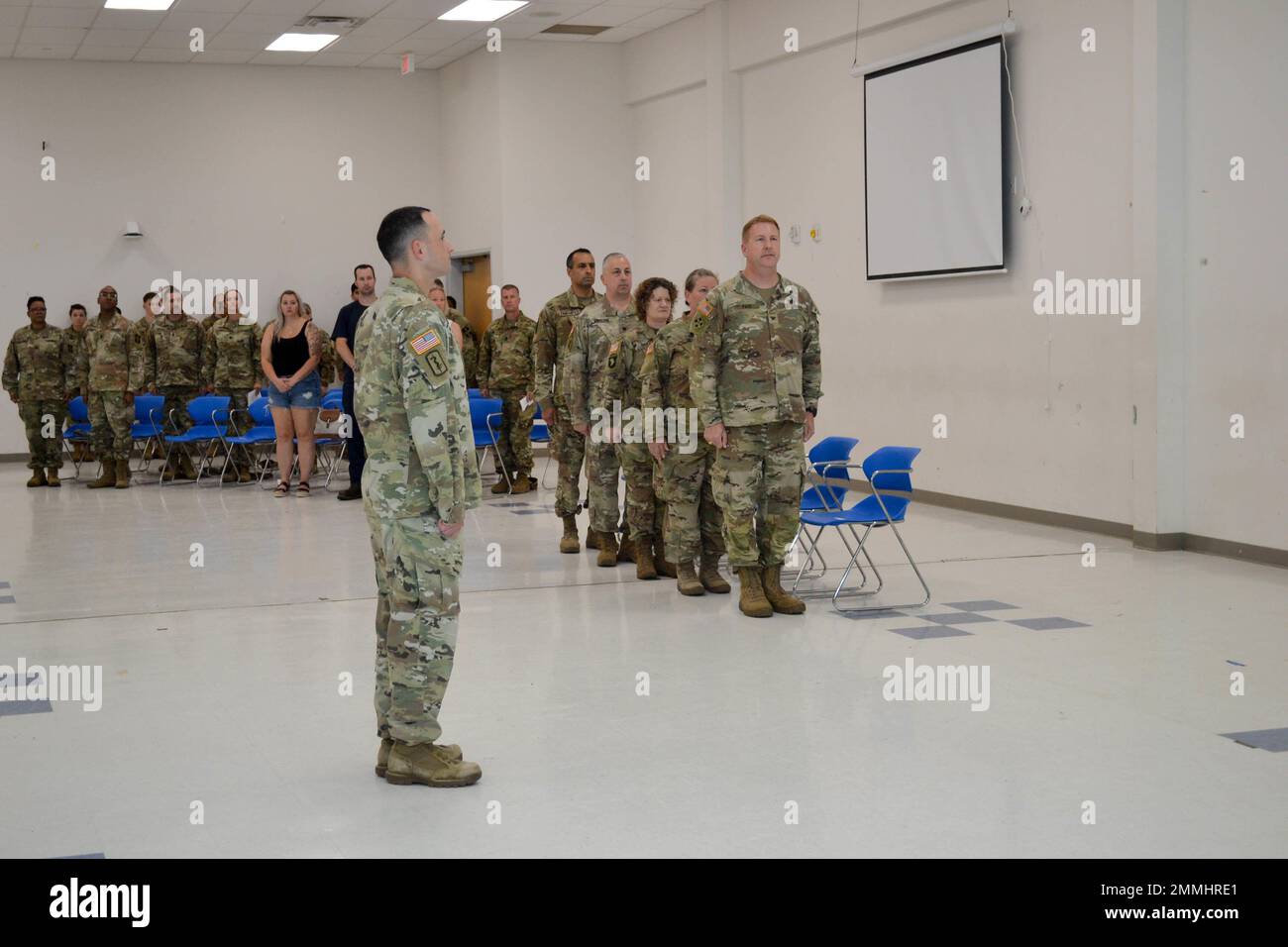 Commanders stand at attention as the color guard enters the room during ...