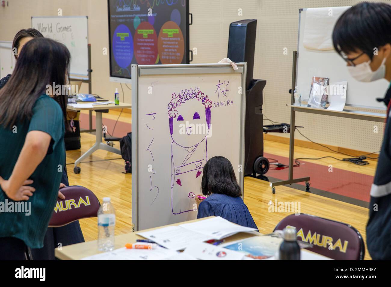 Students from M.C. Perry High School design their team logo during ...