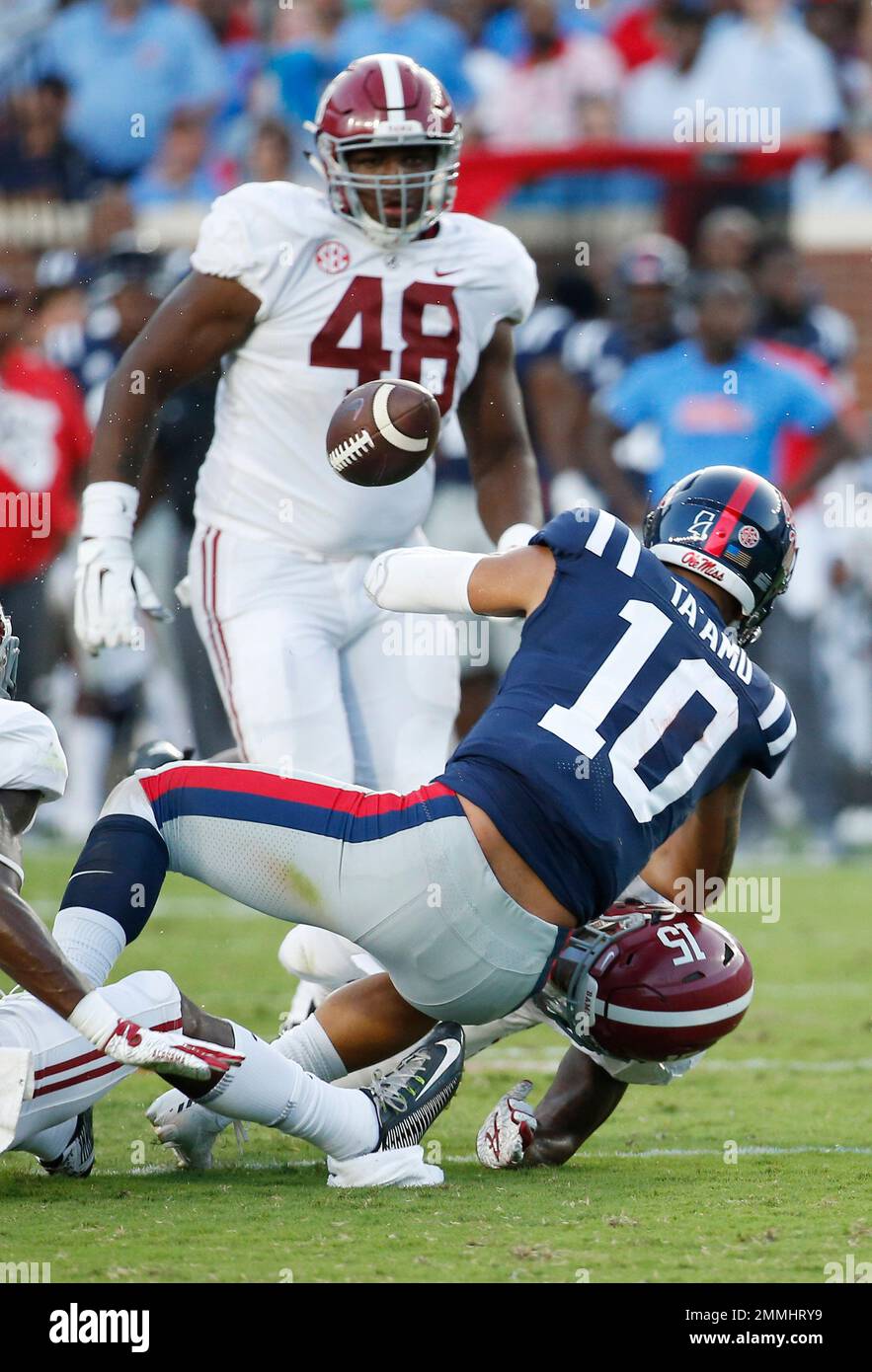 Mississippi quarterback Jordan Ta'amu (10) fumbles after getting hit by ...