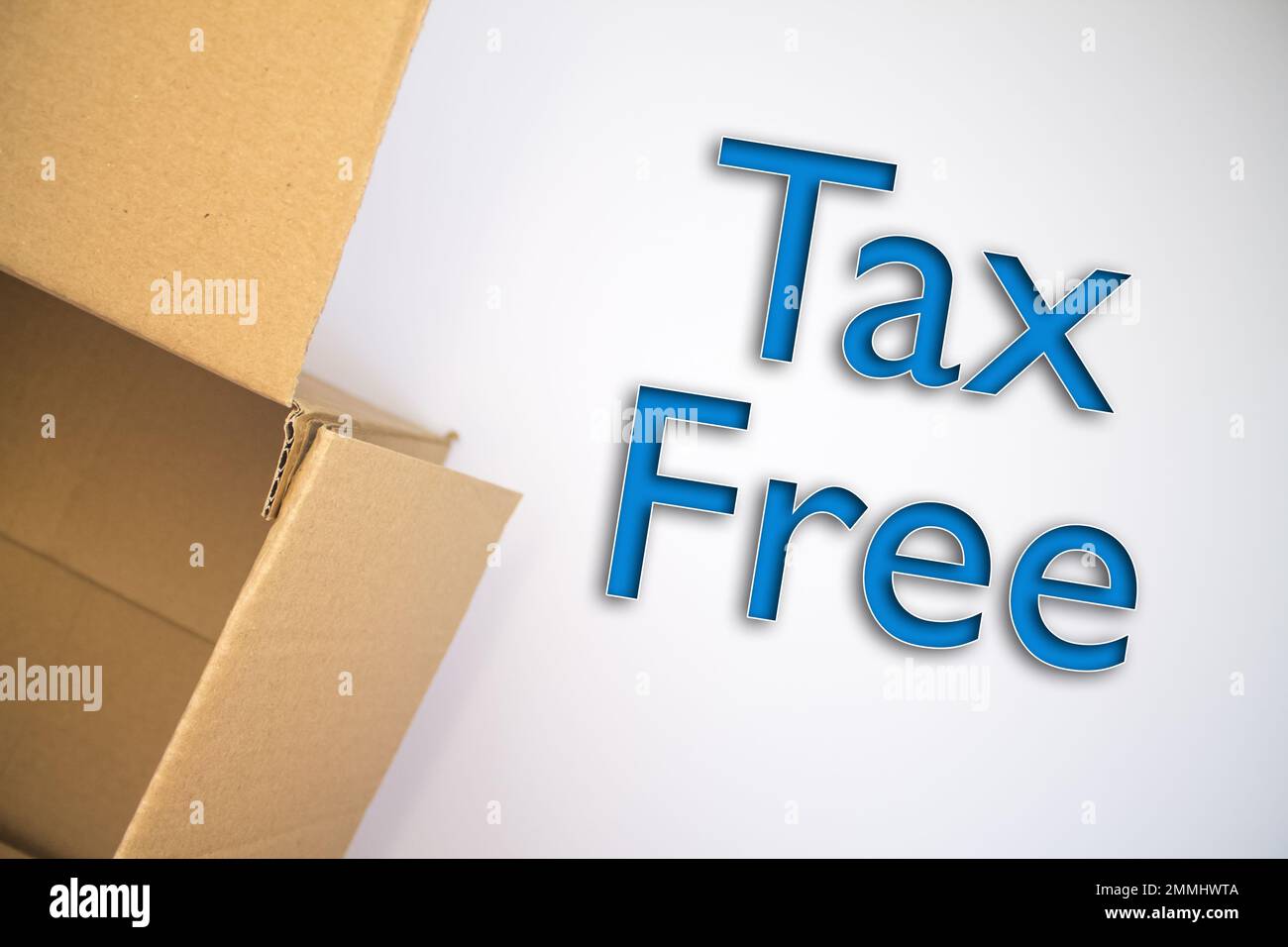 Tax Free word with cardboard box. Brown folded card box Stock Photo - Alamy