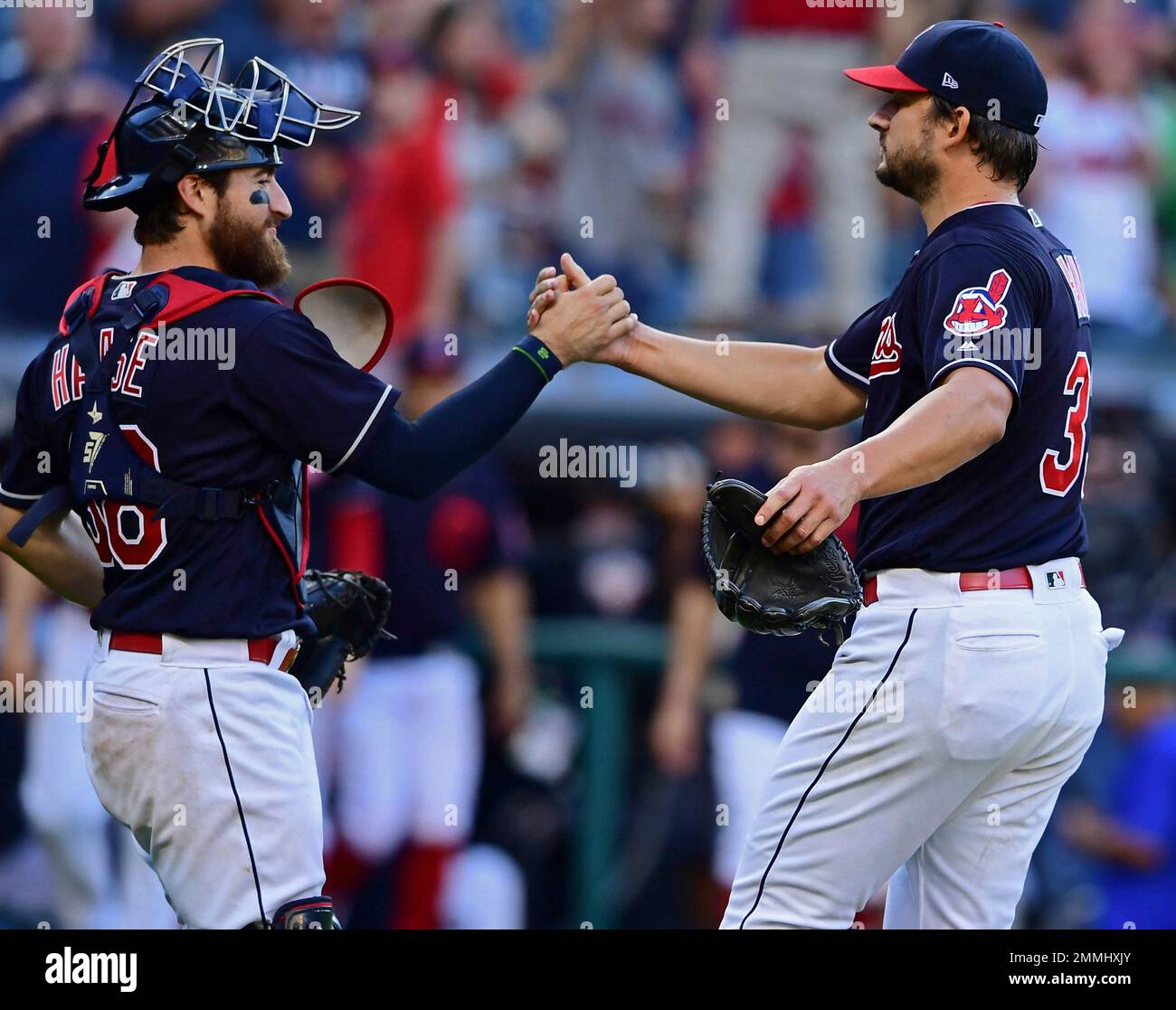 Cleveland Indians relief pitcher Brad Hand, right, is congratulated by ...