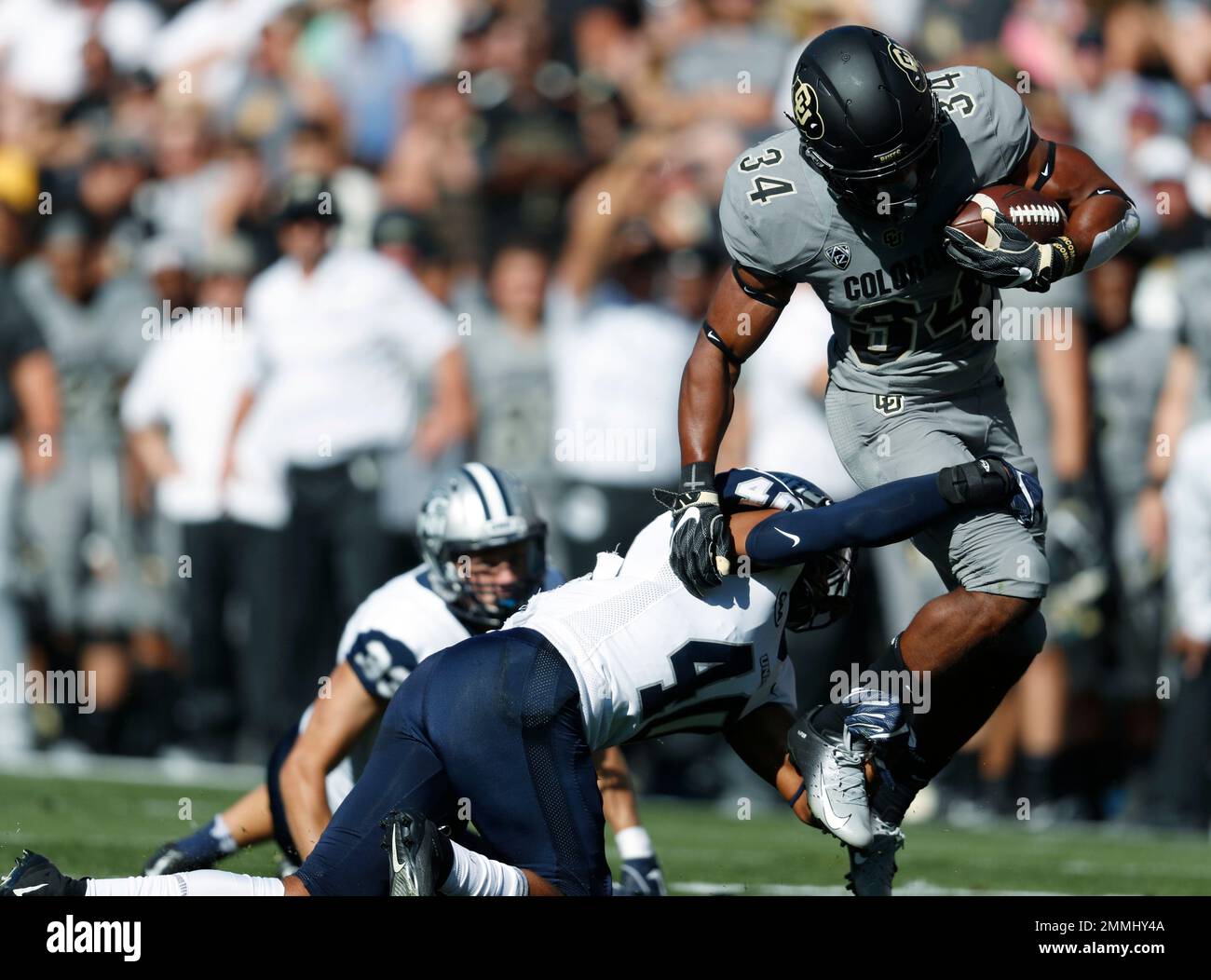 Colorado running back Travon McMillian, right, pulls away from New ...