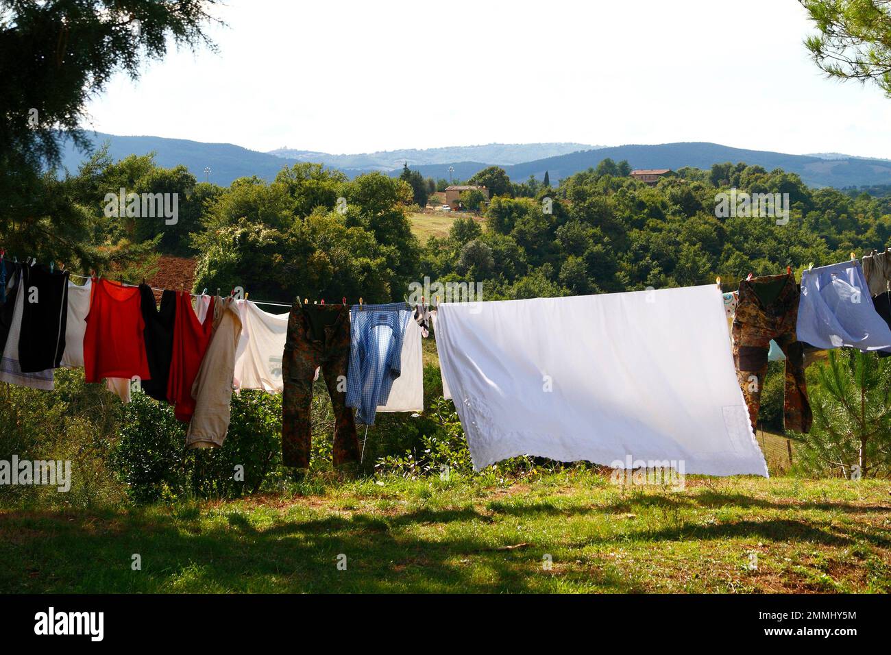 Fresh clothes wash hanging from a clothes line in the garden of a ...