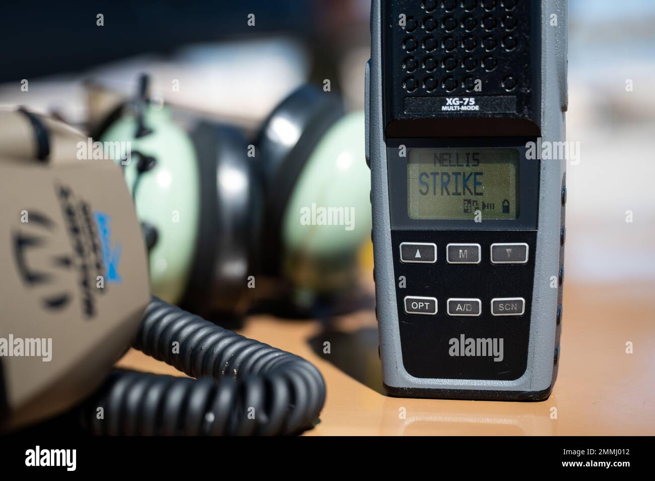 A radio is set by ear protection on the flight line at Nellis Air Force ...
