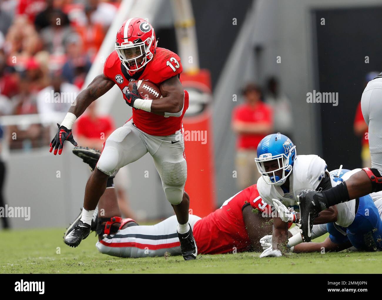 Georgia running back Elijah Holyfield (13) breaks through the Middle ...
