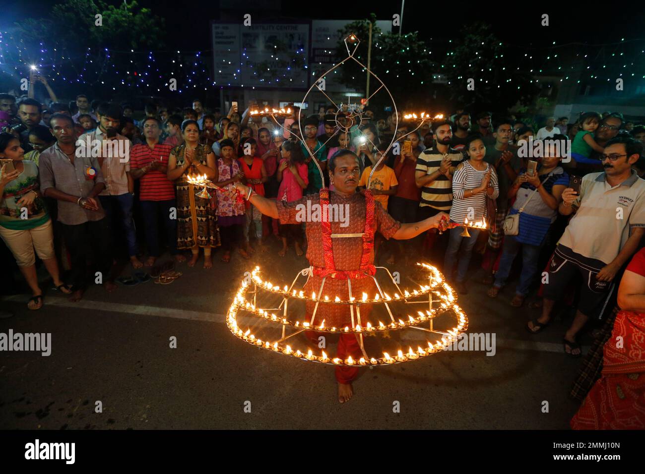 An Indian man Rajnikant Pandya, 42, wears a framed costume decorated by ...