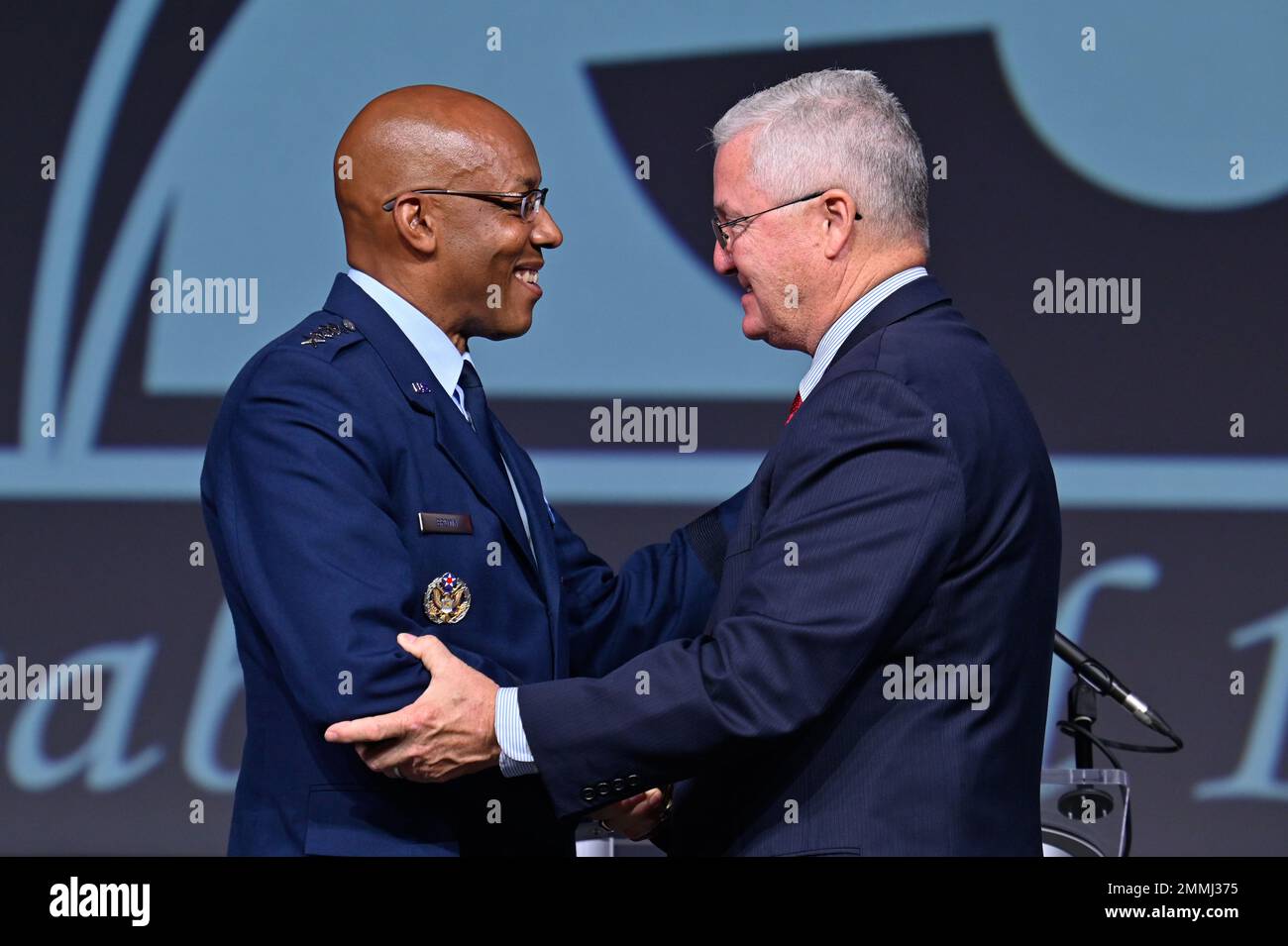 A presenter thanks Air Force Chief of Staff Gen. CQ Brown, Jr. after ...