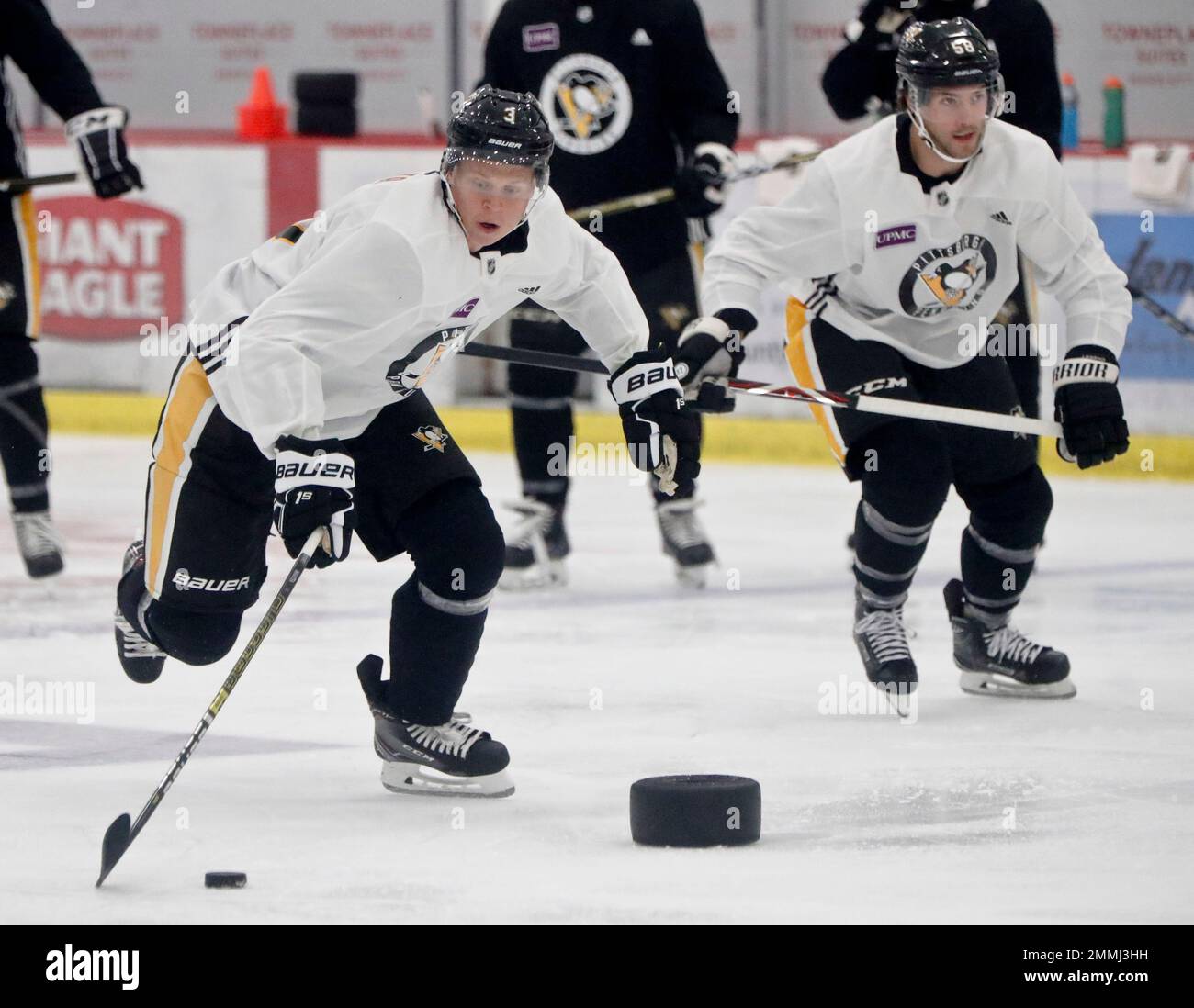 Pittsburgh Penguins' Olli Maatta, left, practices beside Kris Letang ...