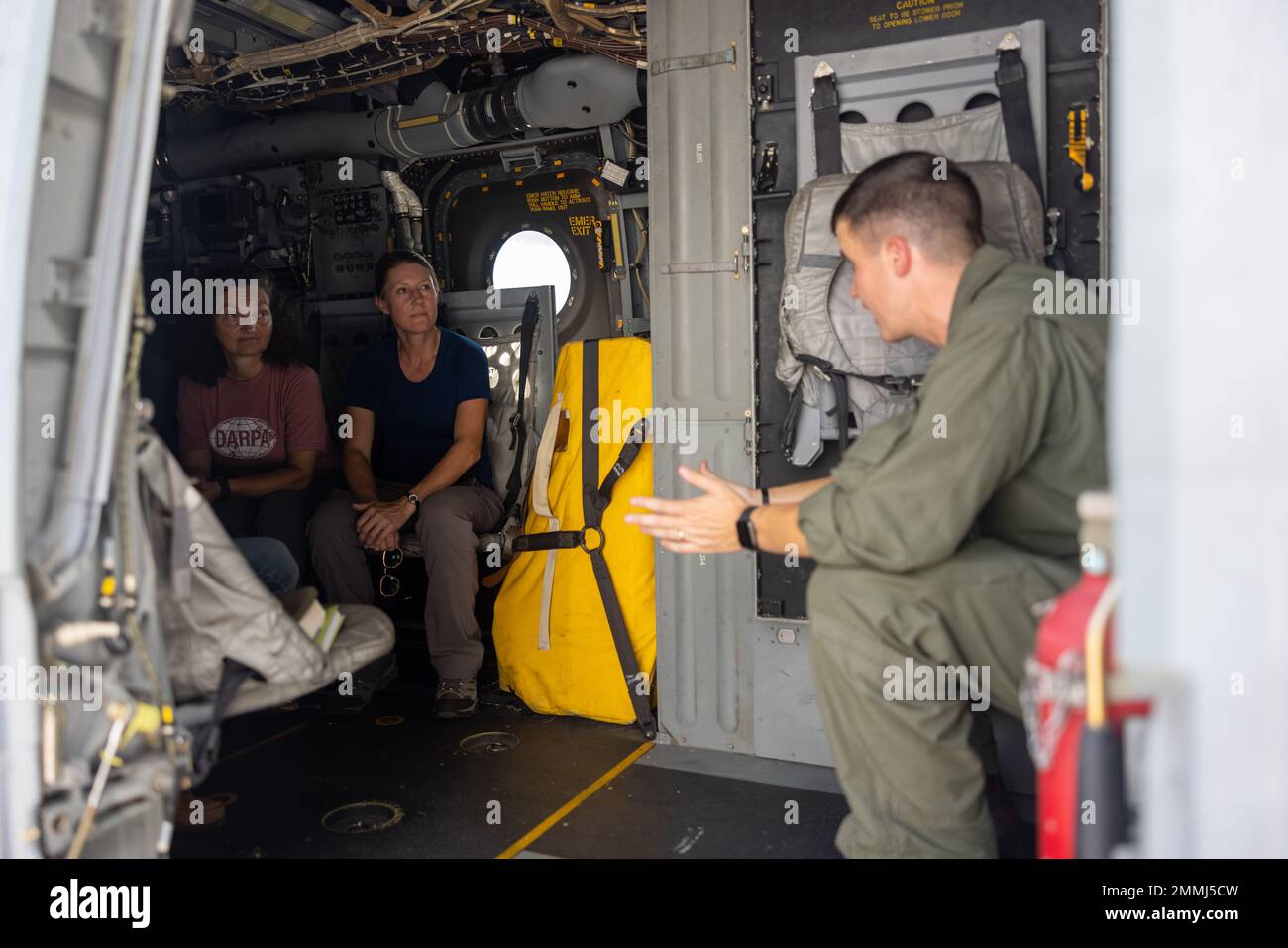 Members of the Defense Science Study Group receive a brief from a U.S ...
