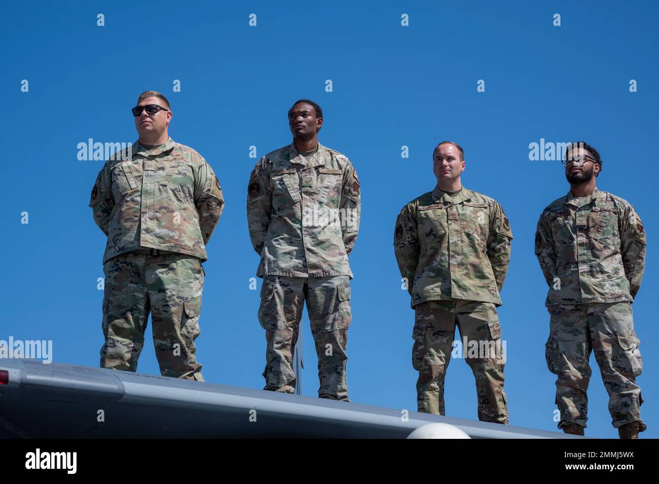 Airmen from the 757th Aircraft Maintenance Squadron stand on the wing ...