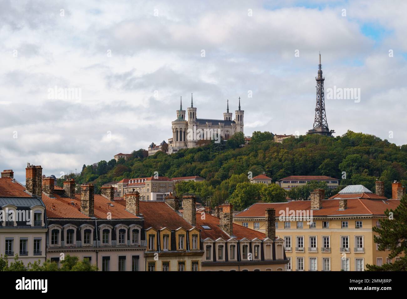 Row of older buildings in Lyon, France with La Basilique Notre Dame de ...