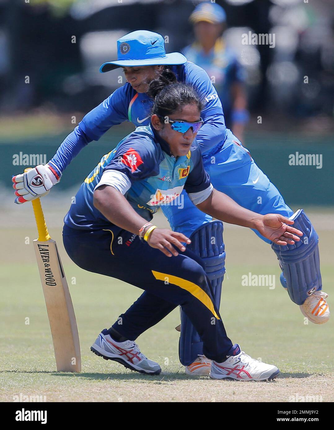 India's Mithali Raj collides with Sri Lanka's Chamari Atapattu, front ...
