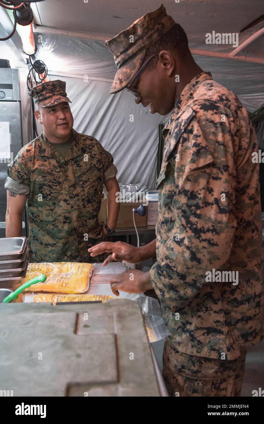 U.S. Marine Corps Master Gunnery Sgt. Anthony Gonzales, left, a food ...