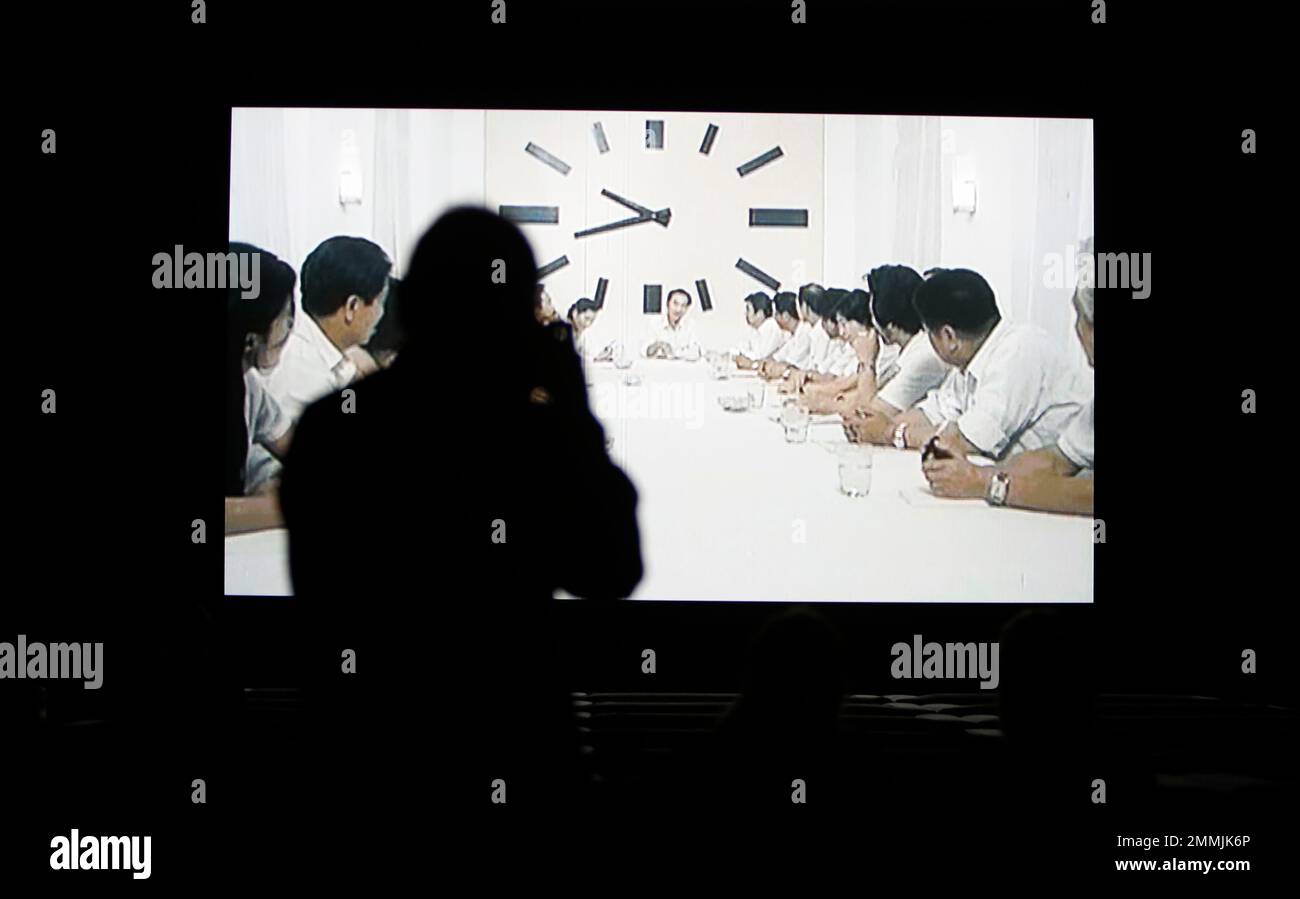 People watch a section of the 24 hour video installation by Christian ...