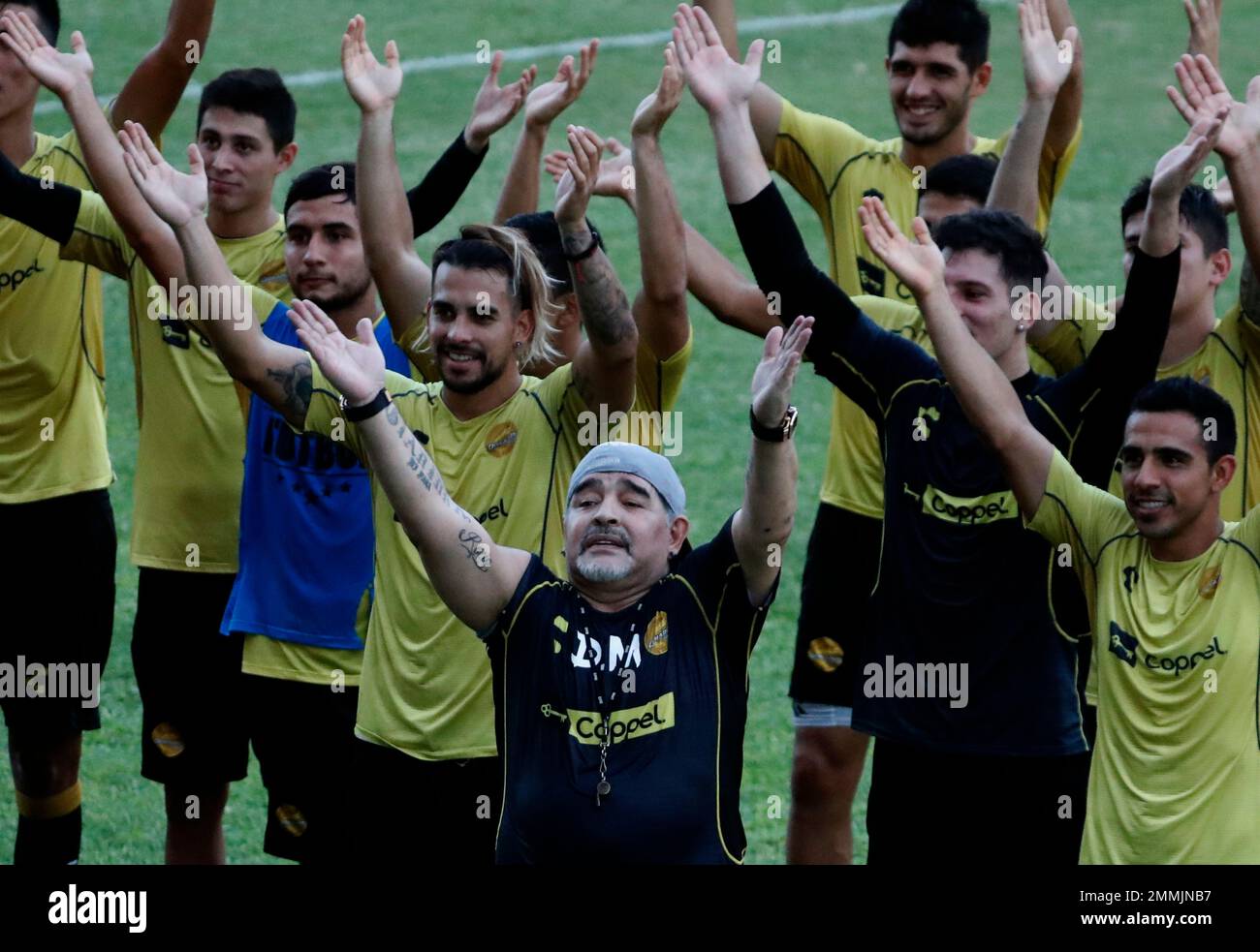 Former soccer great Diego Maradona sings with his team and fans in ...