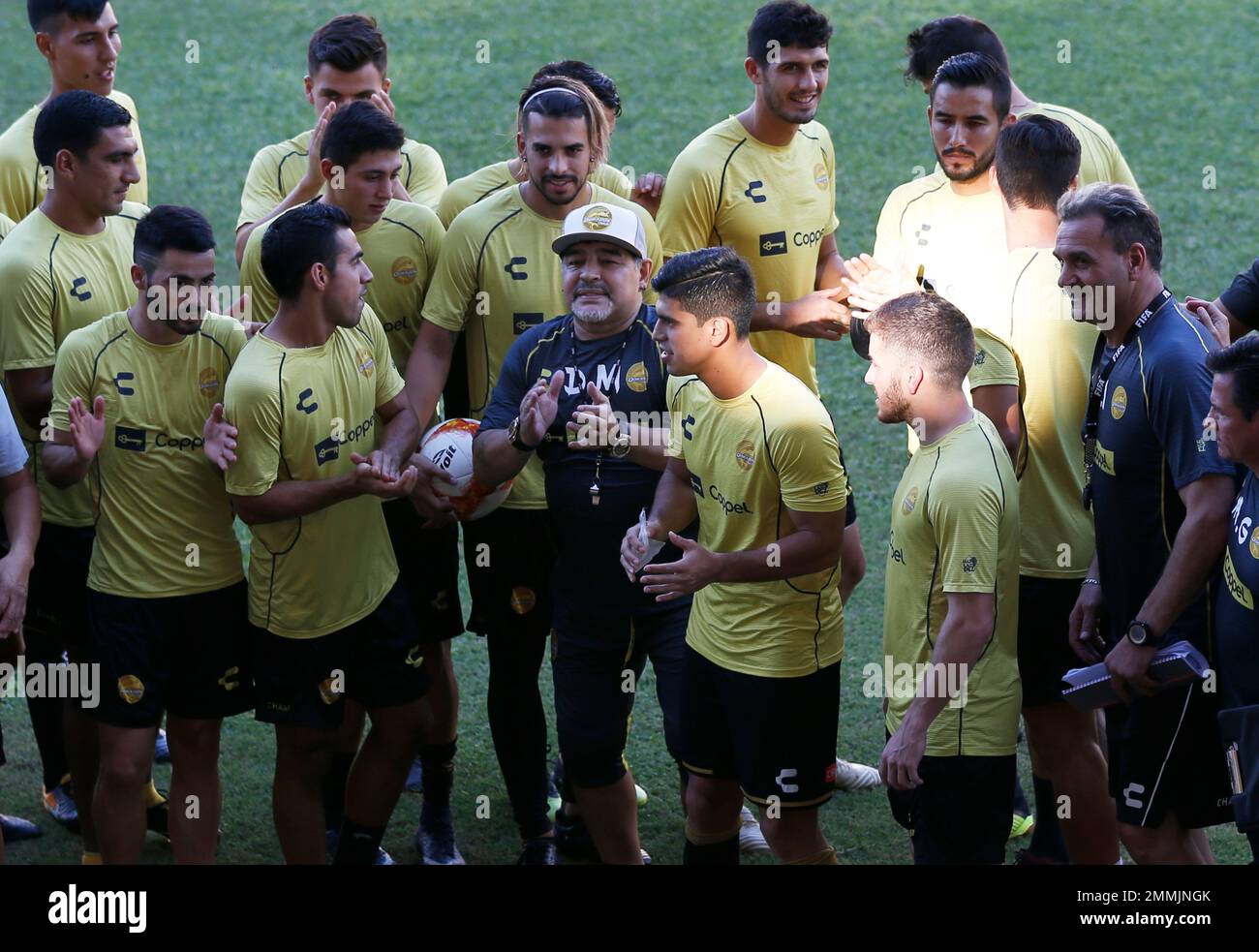 Former soccer great Diego Maradona, center, stands with his players on ...