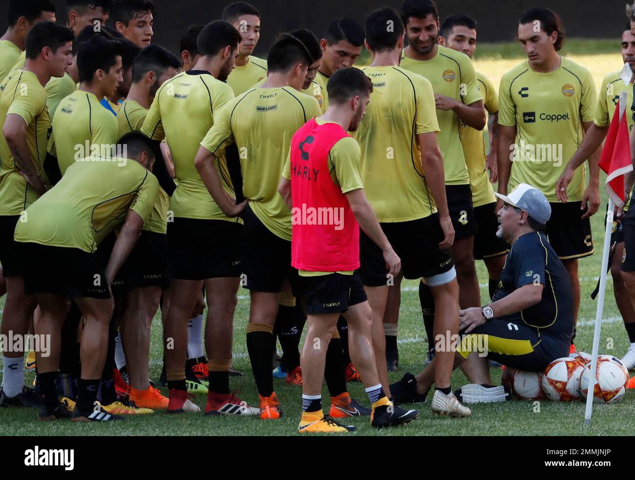 Former soccer great Diego Maradona, sitting, talks to his players on ...