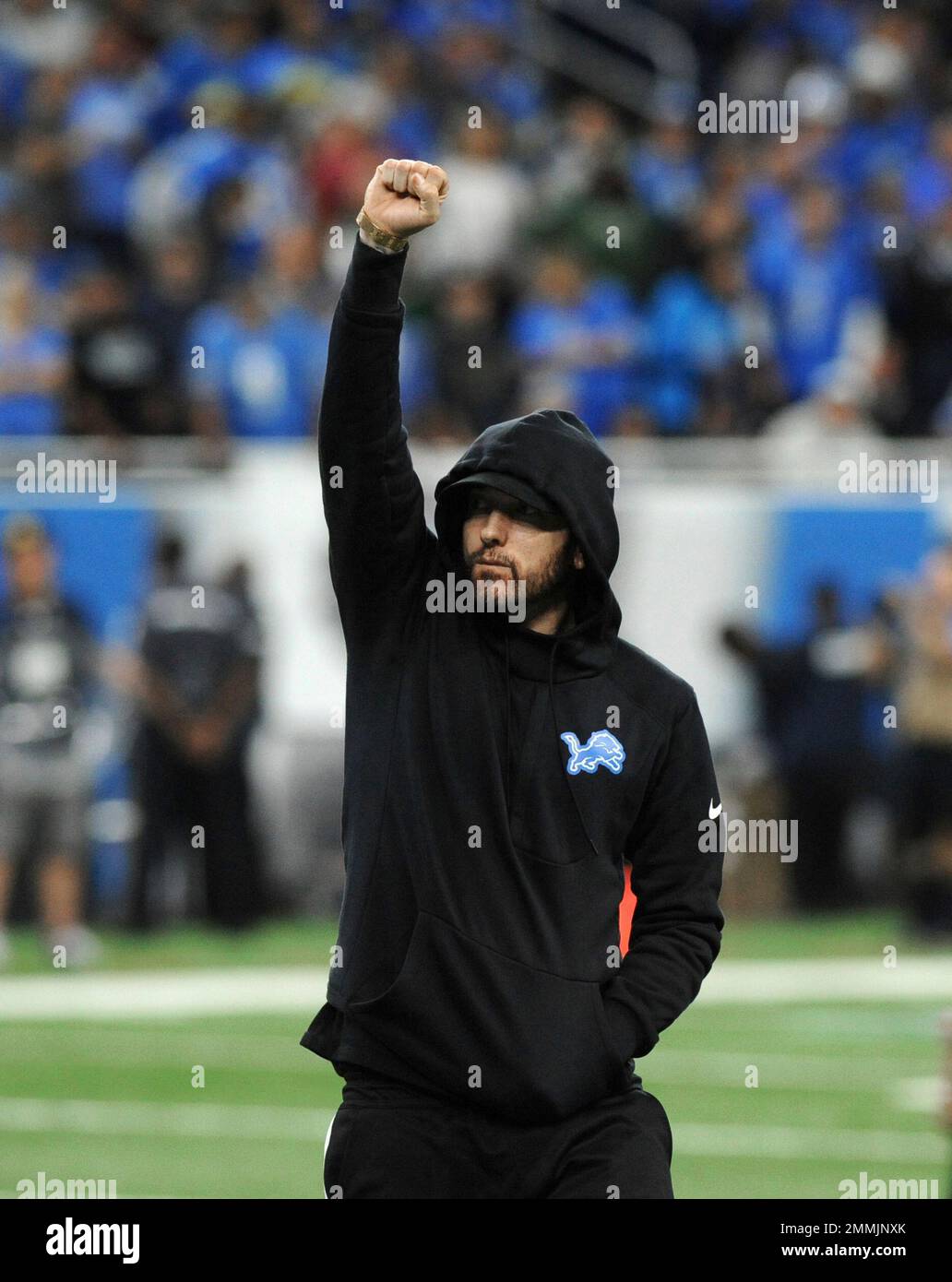 Eminem acknowledges the crowd at an NFL football game between the ...