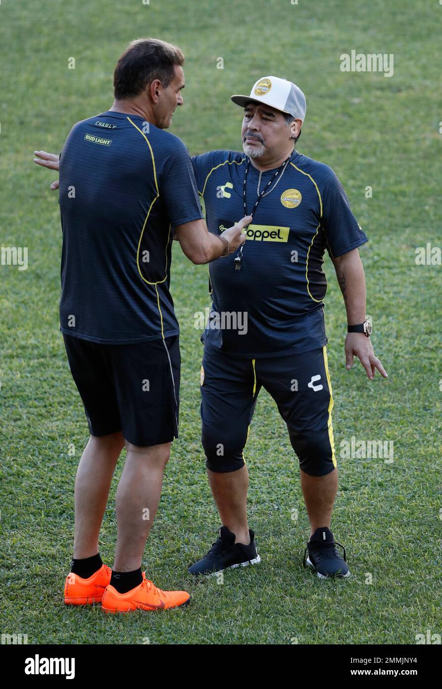 Former soccer great Diego Maradona, right, and Luis Islas chat as they ...
