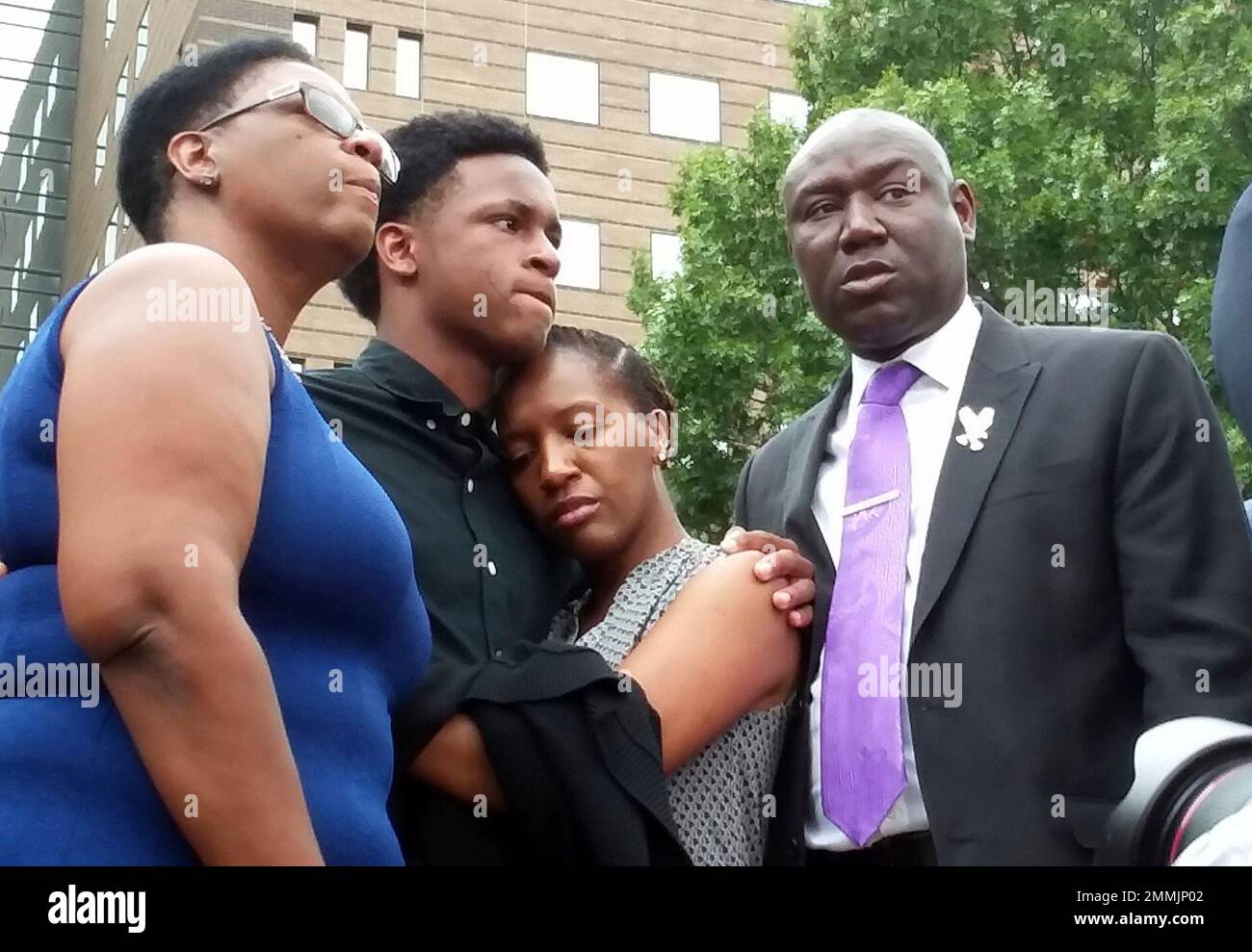 Brandt Jean, center left, brother of shooting victim Botham Jean, hugs ...