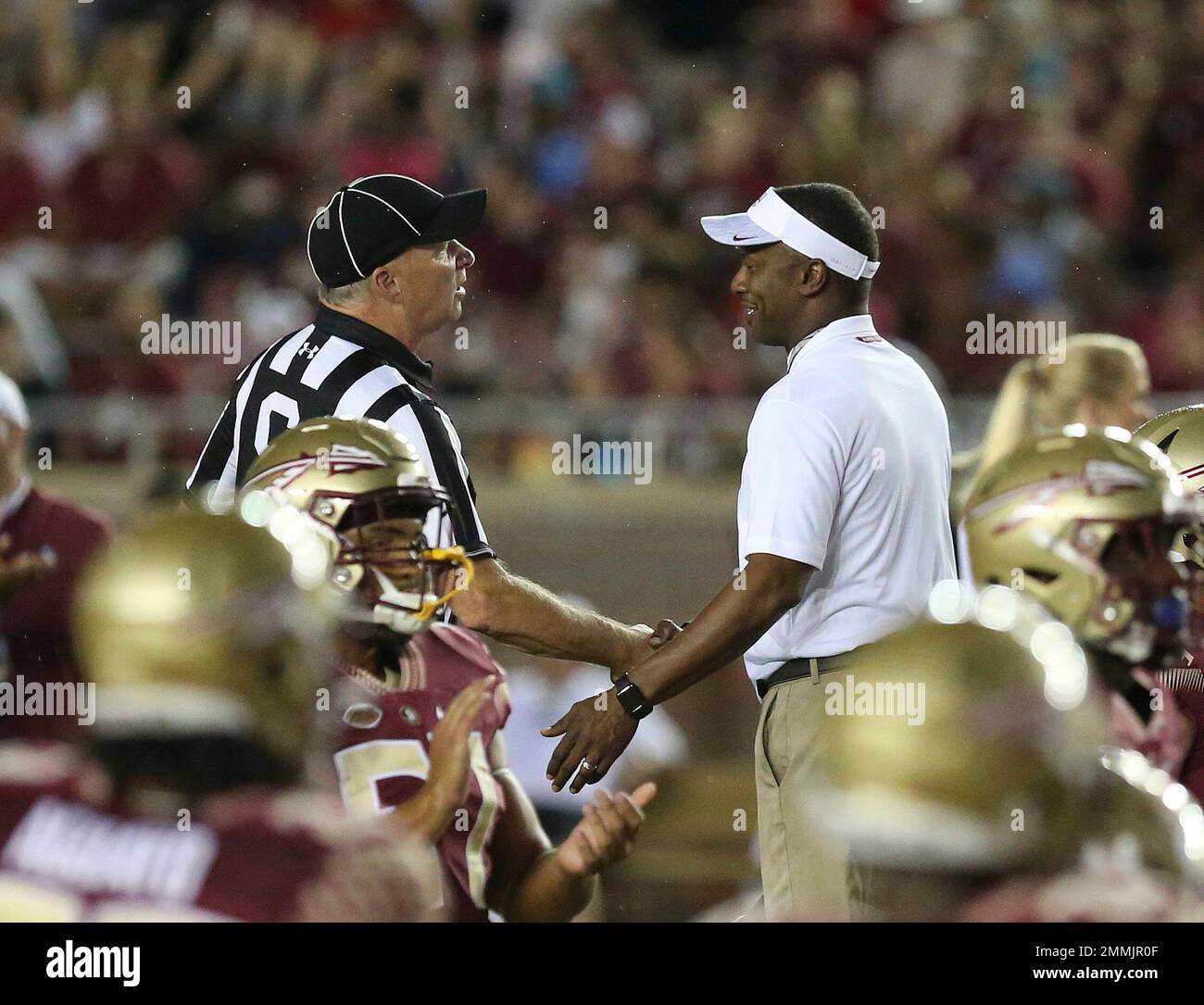 Florida State head coach Willie Taggart talks with side judge Angelo ...