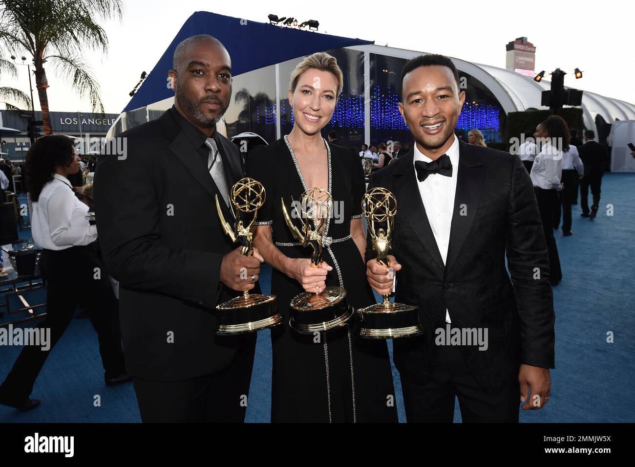 Mike Jackson, from left, Ty Stiklorius, and John Legend attend the ...