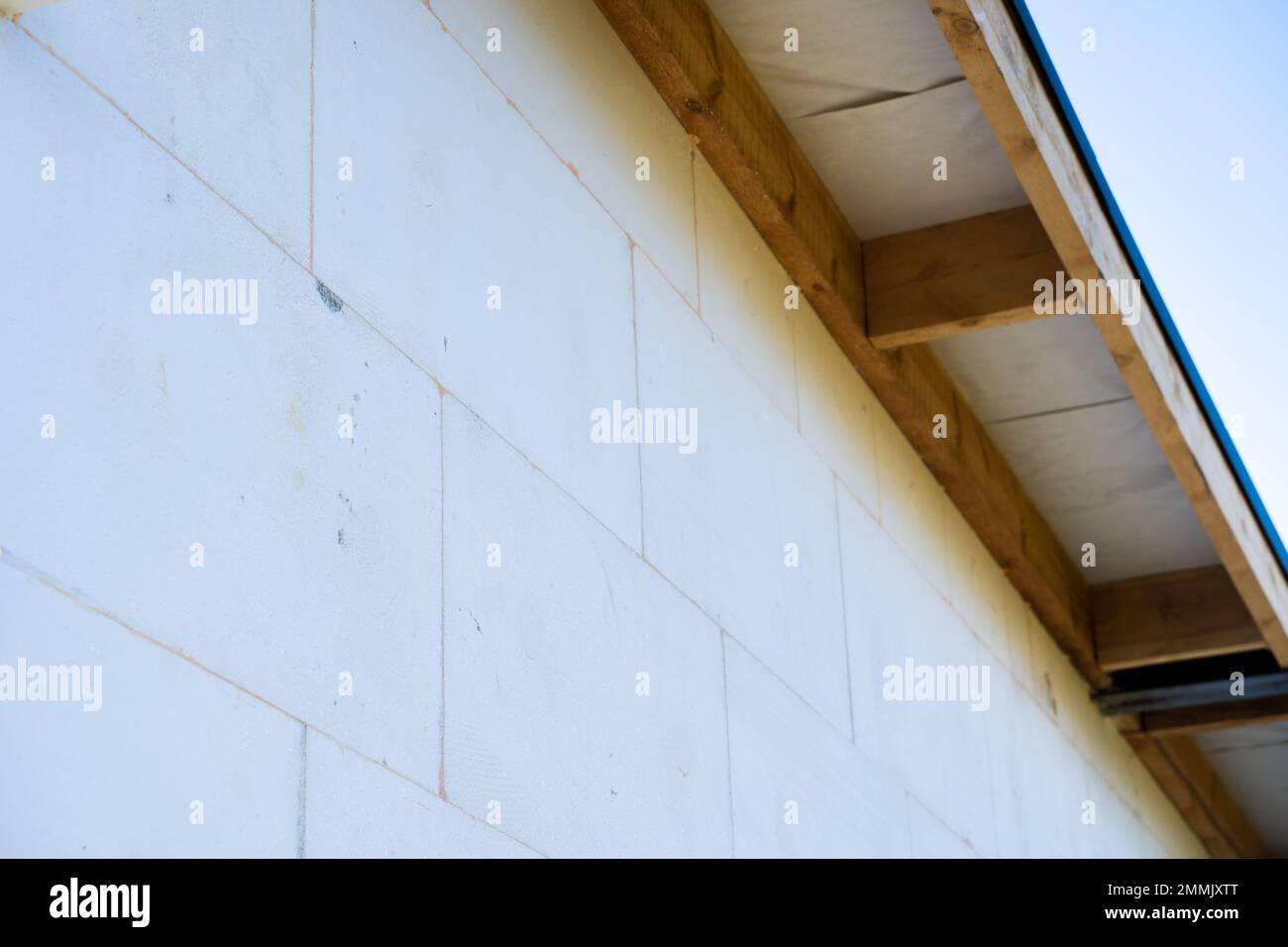 The wall of the house is insulated with white polystyrene foam ...