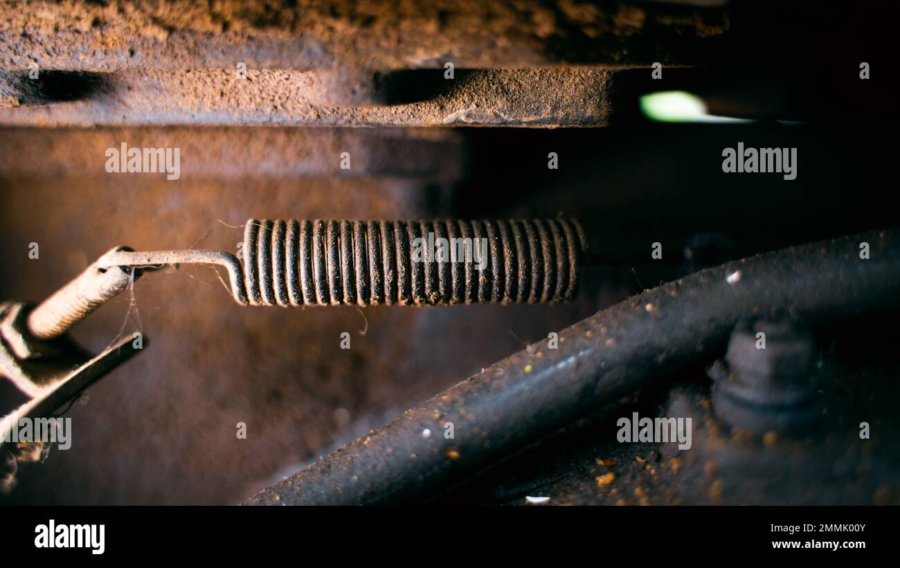 Rusty spring close-up in the controls of a walk-behind tractor Stock ...