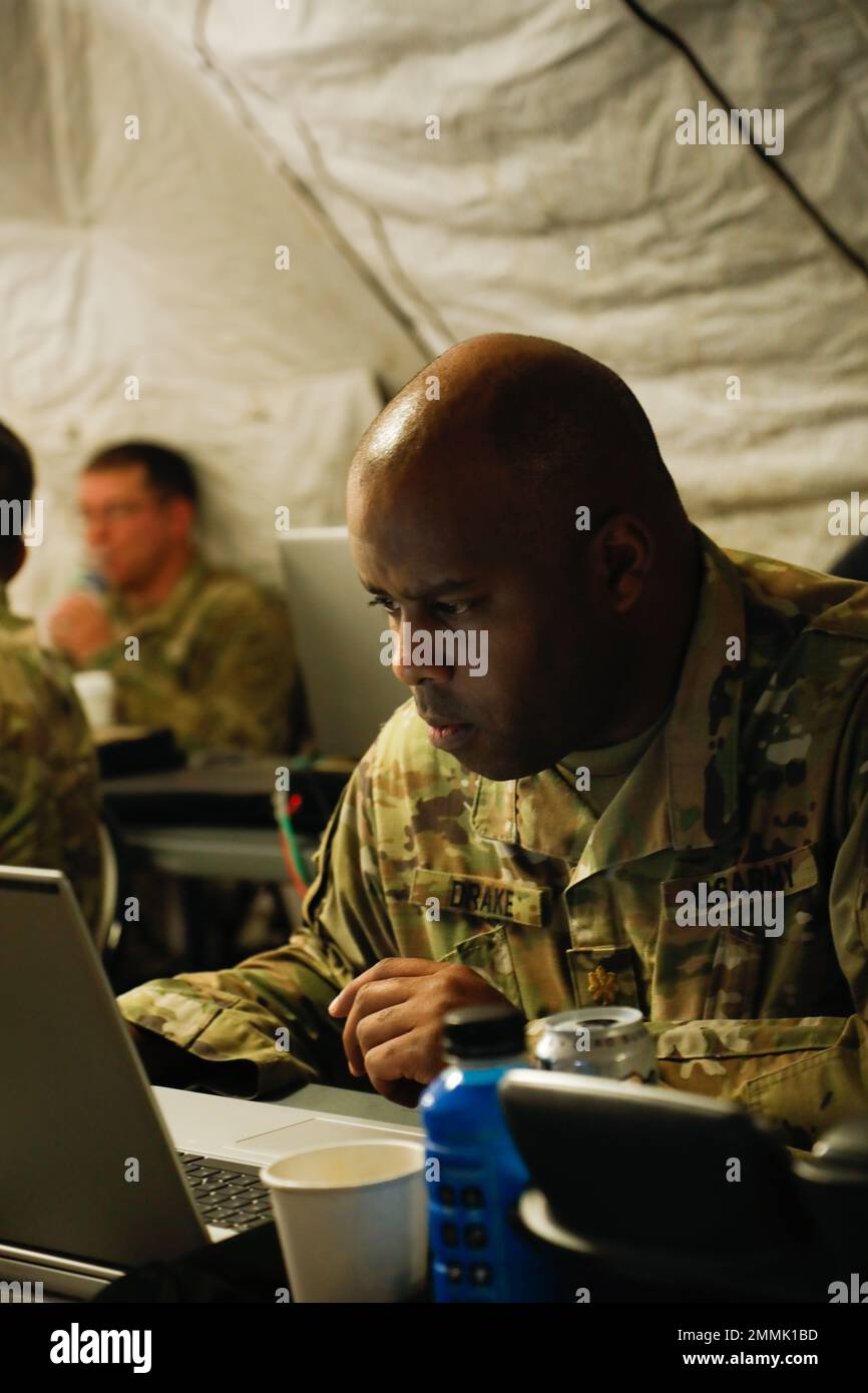 Maj. Deven Drake, watch officer for U.S. Army Central, manages and ...