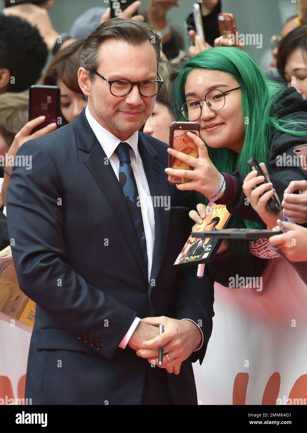 Christian Slater poses for a photo with a fan as he attends a gala for ...
