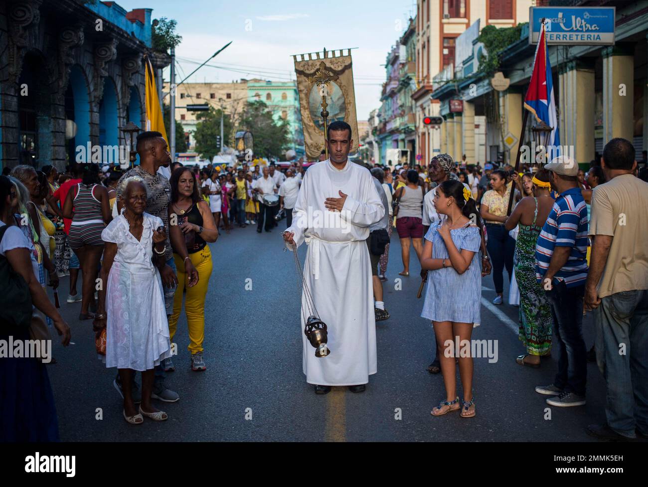 A Catholic priest spreads incense as he leads the annual Virgin of ...