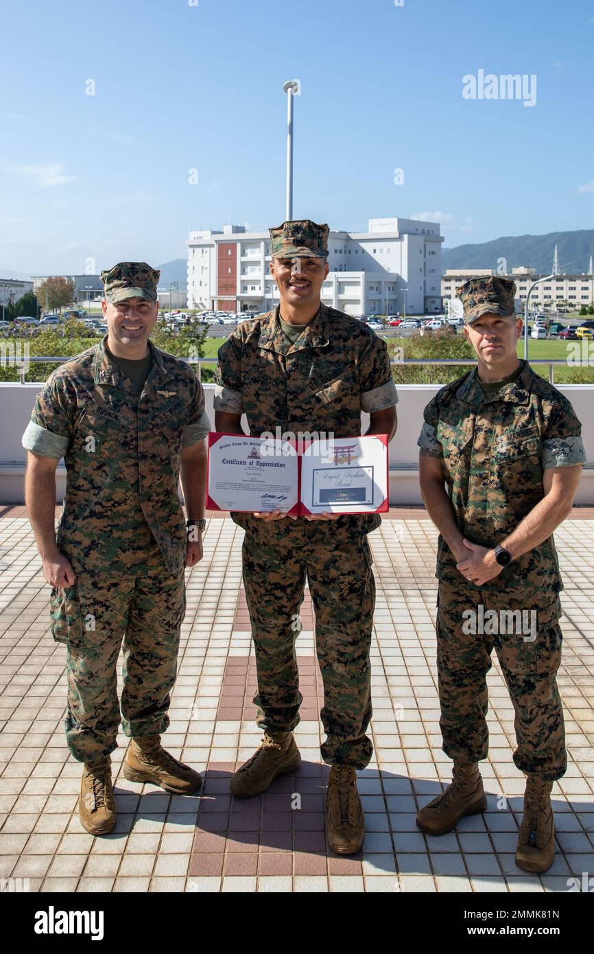 U.S. Marine Corps Staff Sgt. Tajee Dawson, center, poses for a photo ...