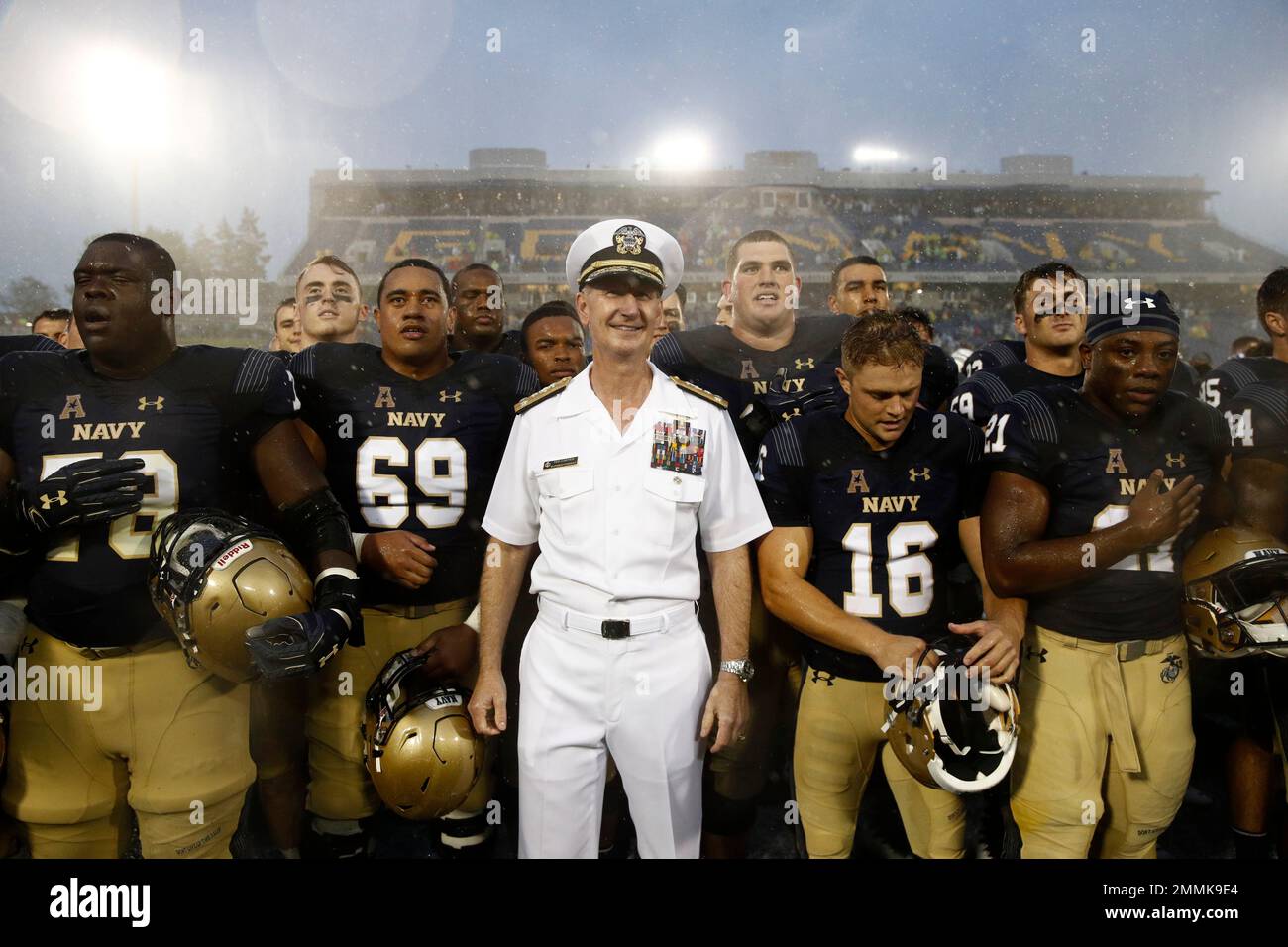 U.S. Naval Academy superintendent Ted Carter, center, stands with Navy ...