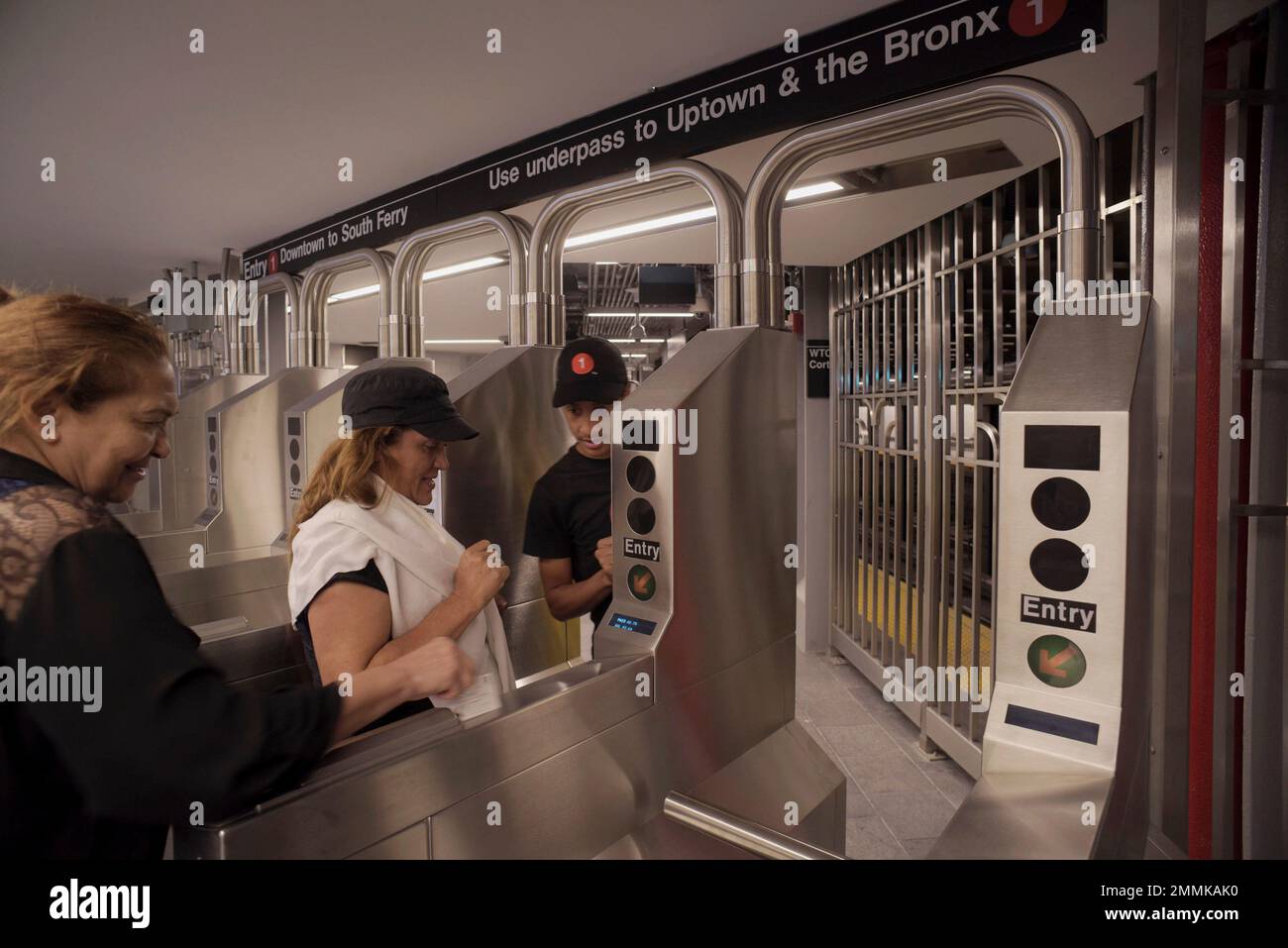 Passengers use a card to enter the newly-opened WTC Cortlandt subway ...