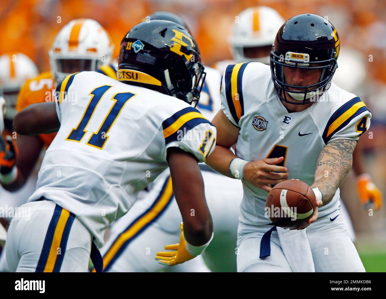 East Tennessee State University quarterback Logan Marchi (4) hands the ...