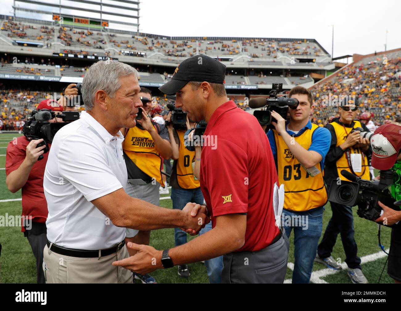 Iowa head coach Kirk Ferentz, left, shakes hands with Iowa State head ...