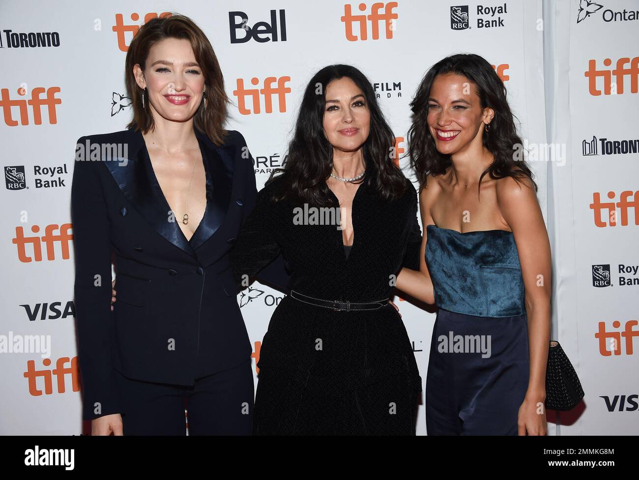 Actors Tess Haubrich, left, Monica Bellucci and Caroline Ford attend ...
