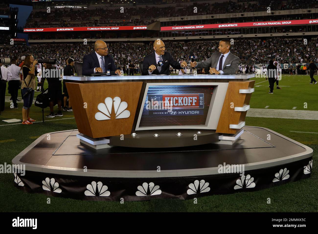 NBC sportscasters gather before an NFL football game between the ...