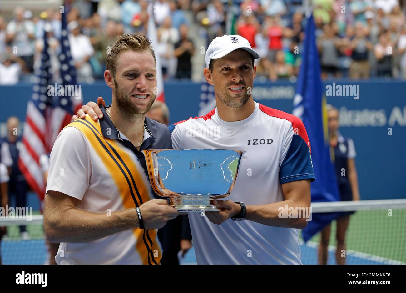 Jack Sock, left, and Mike Bryan hold the trophy after defeating Lukasz ...