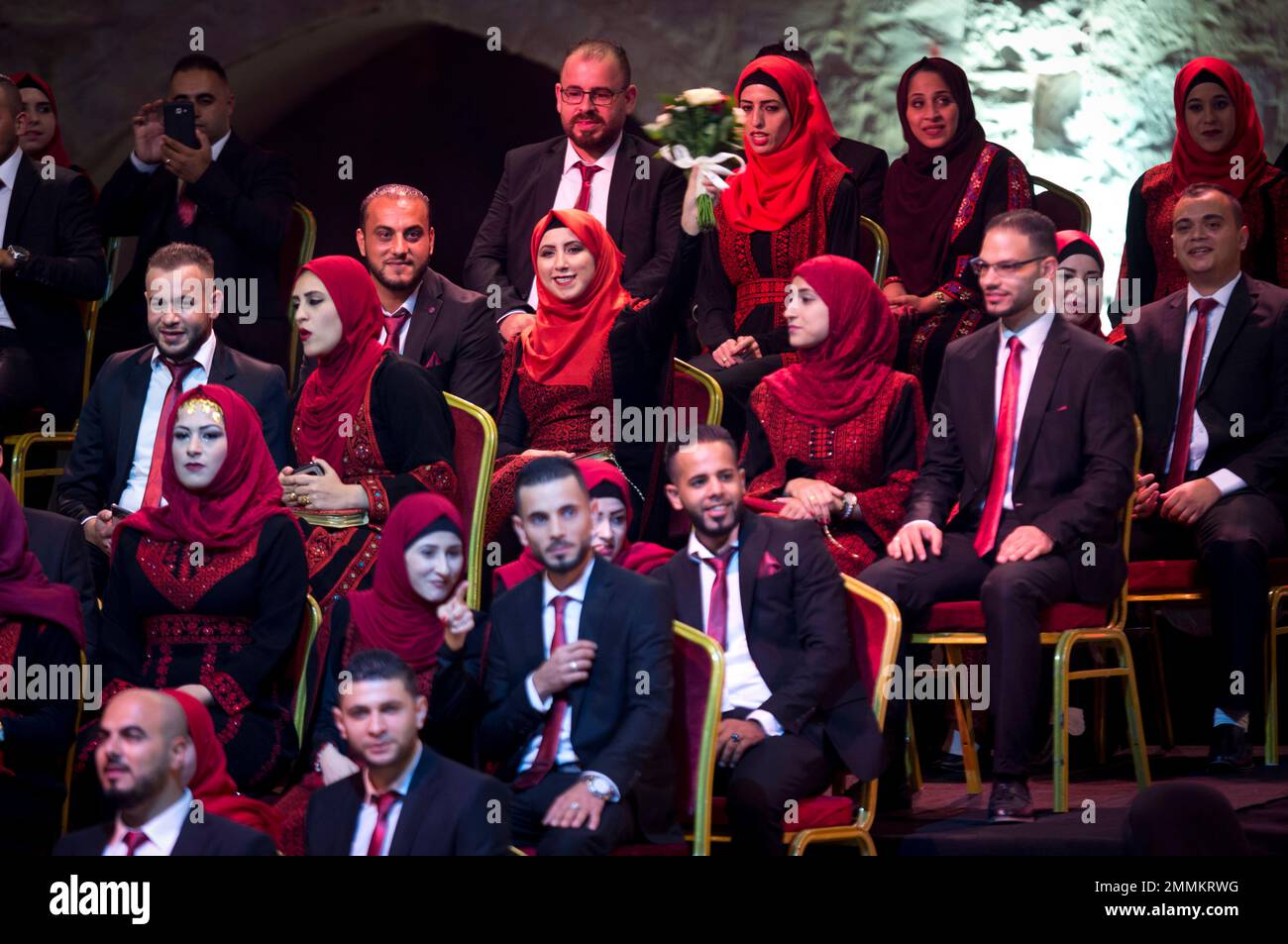 Palestinian brides and sit during a mass wedding event in the West Bank ...