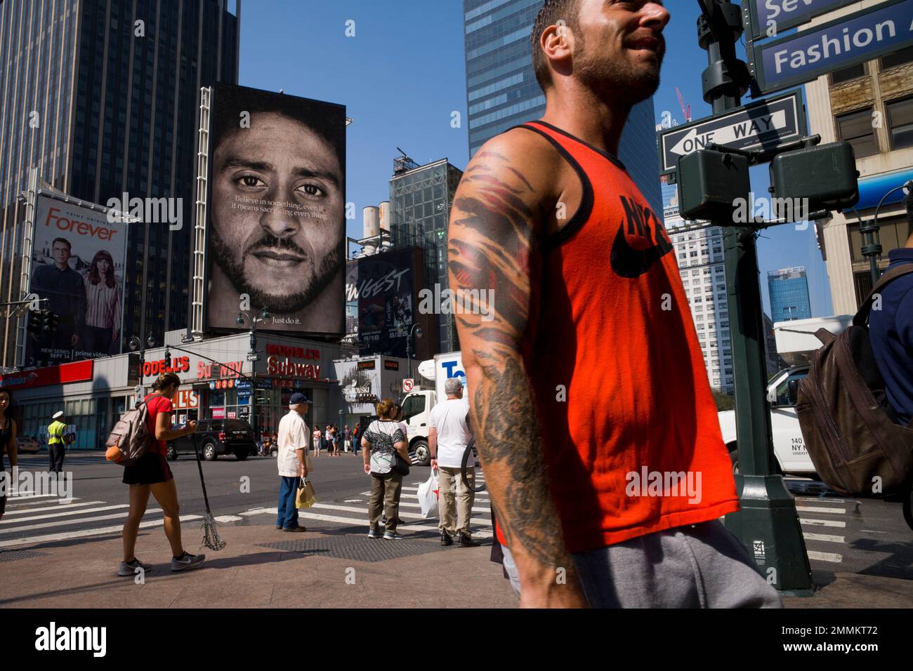 CORRECTS DATE- People walk by a Nike advertisement featuring Colin ...