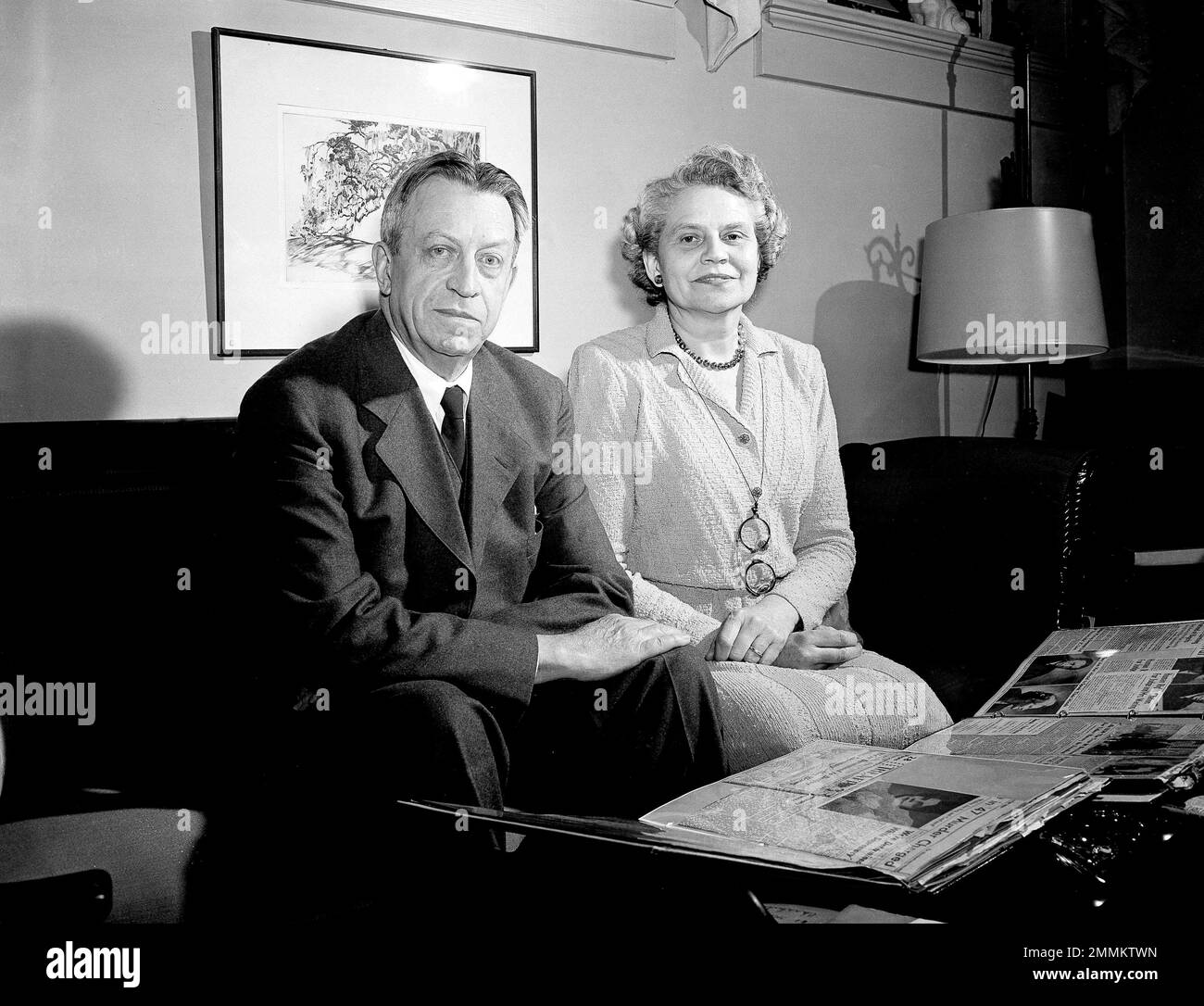Judge Julius Waties Waring and his wife Elizabeth look at scrap books ...