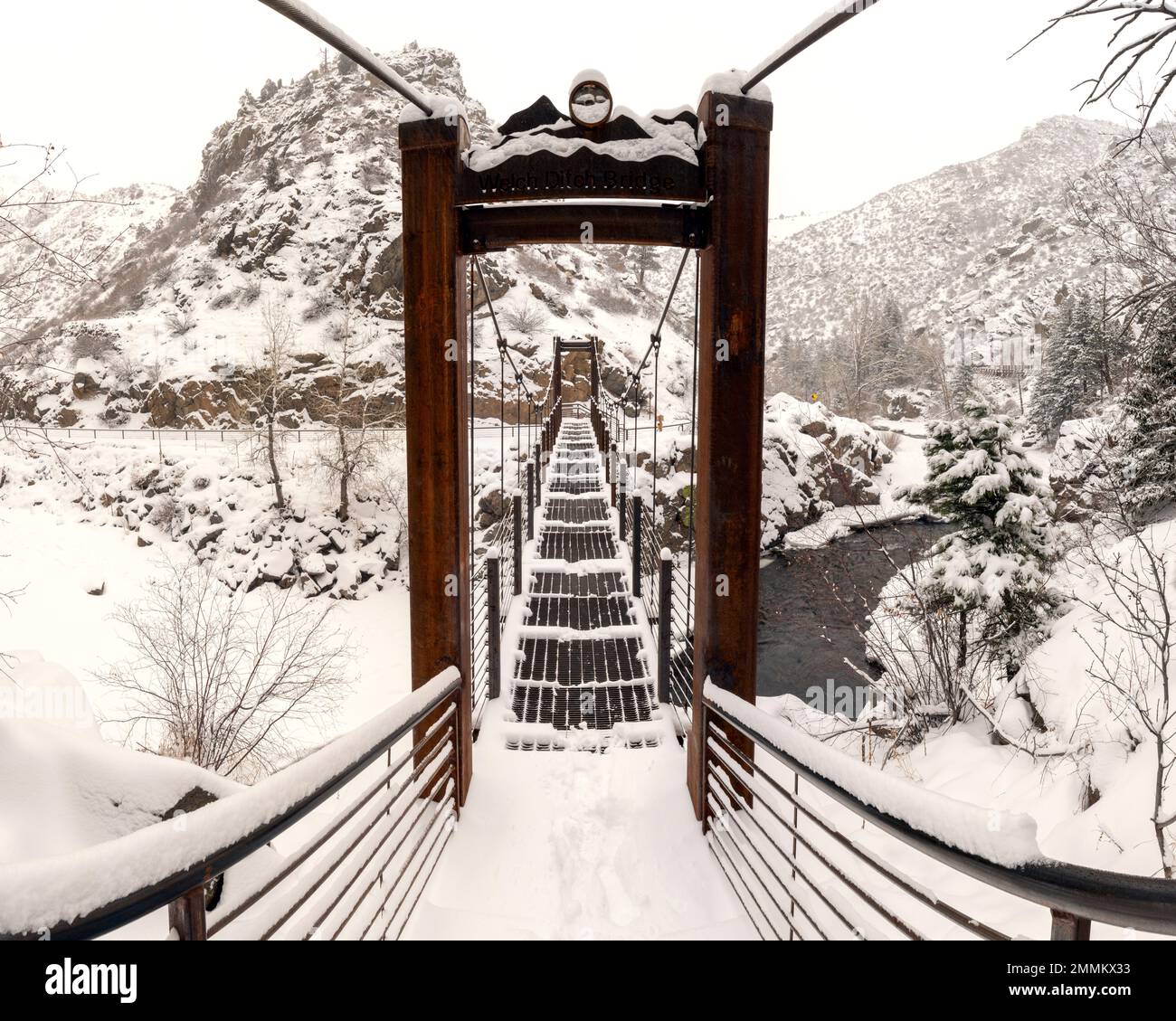 Snow-covered suspension bridge on Welch Ditch Trail in Clear Creek ...