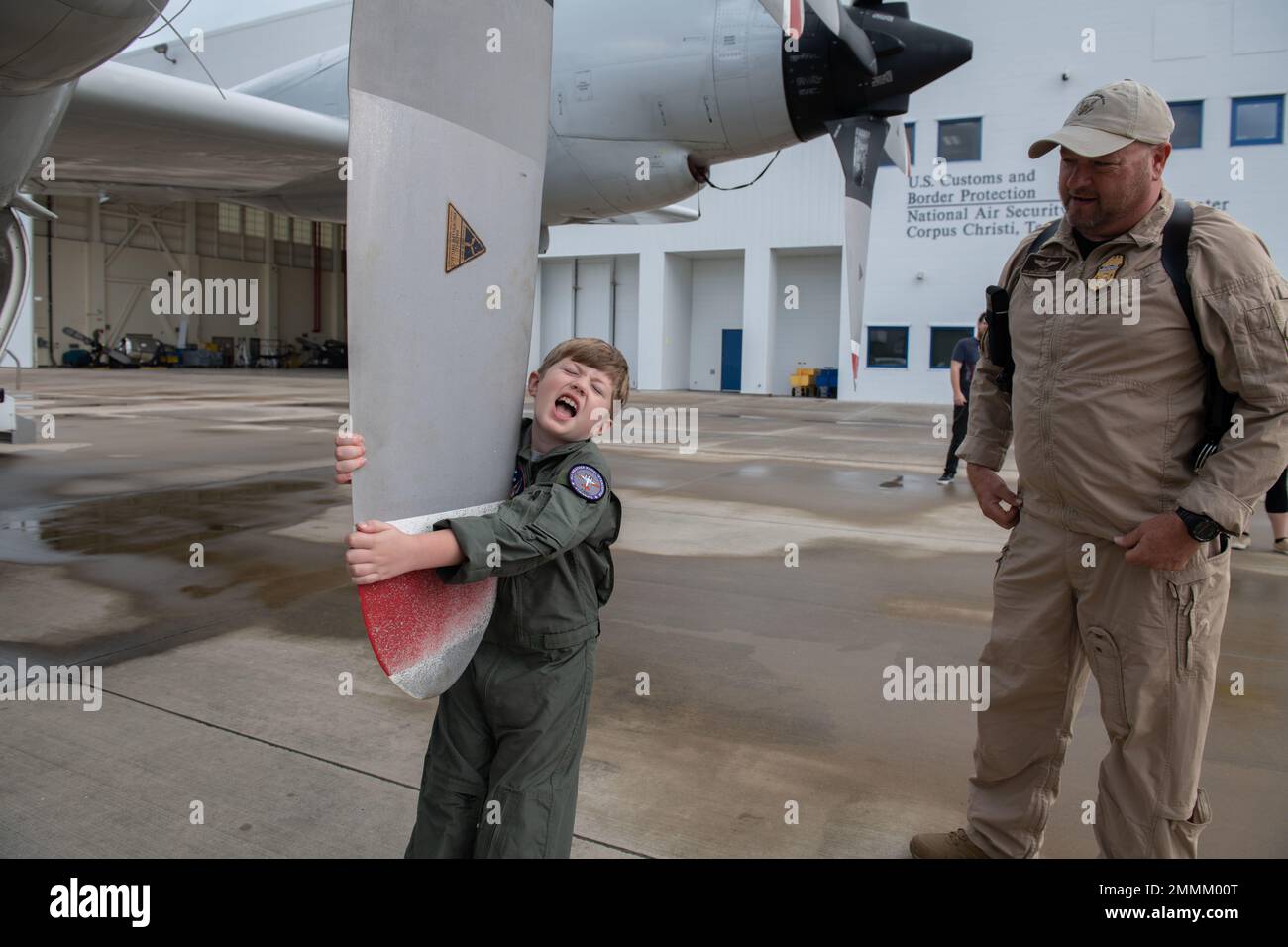 Seth Wilkey, Pilot for a Day, attempts to rotate a propeller of a U.S ...
