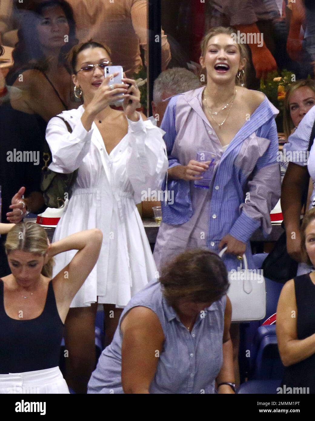Bella Hadid, top left, and Gigi Hadid attend the quarterfinals of the U ...
