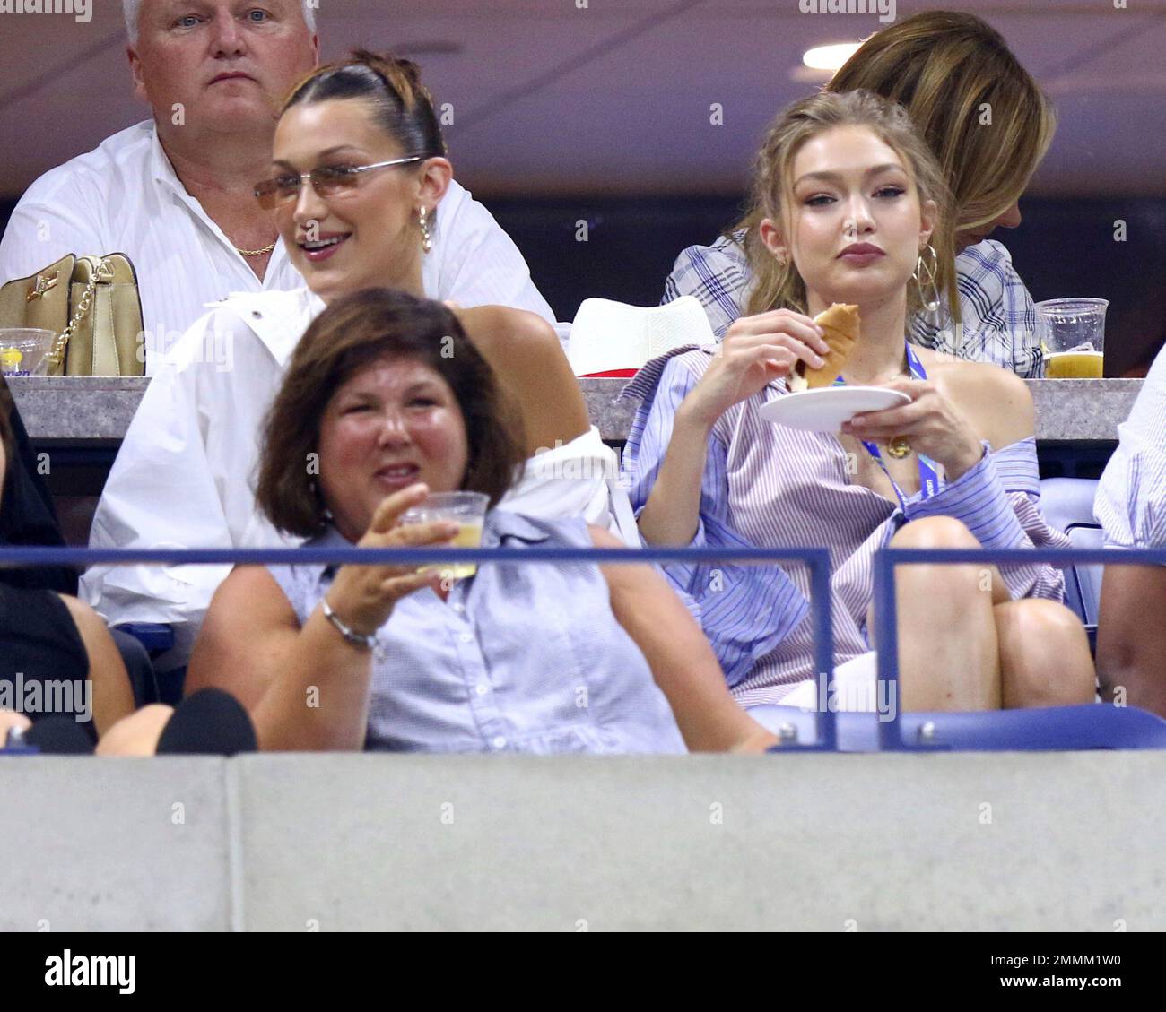 Bella Hadid, top left, and Gigi Hadid attend the quarterfinals of the U ...
