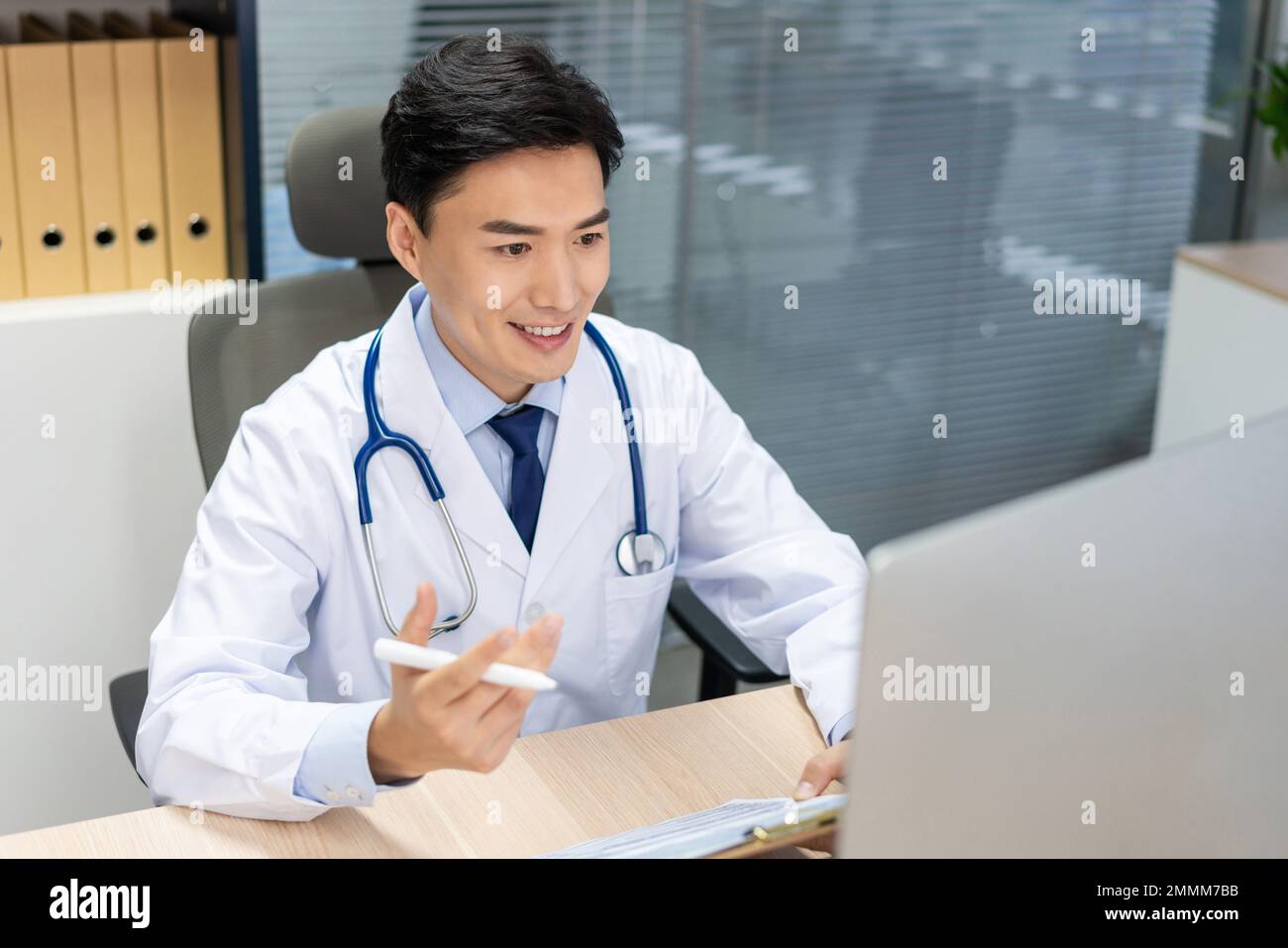The young doctor working in the office Stock Photo - Alamy