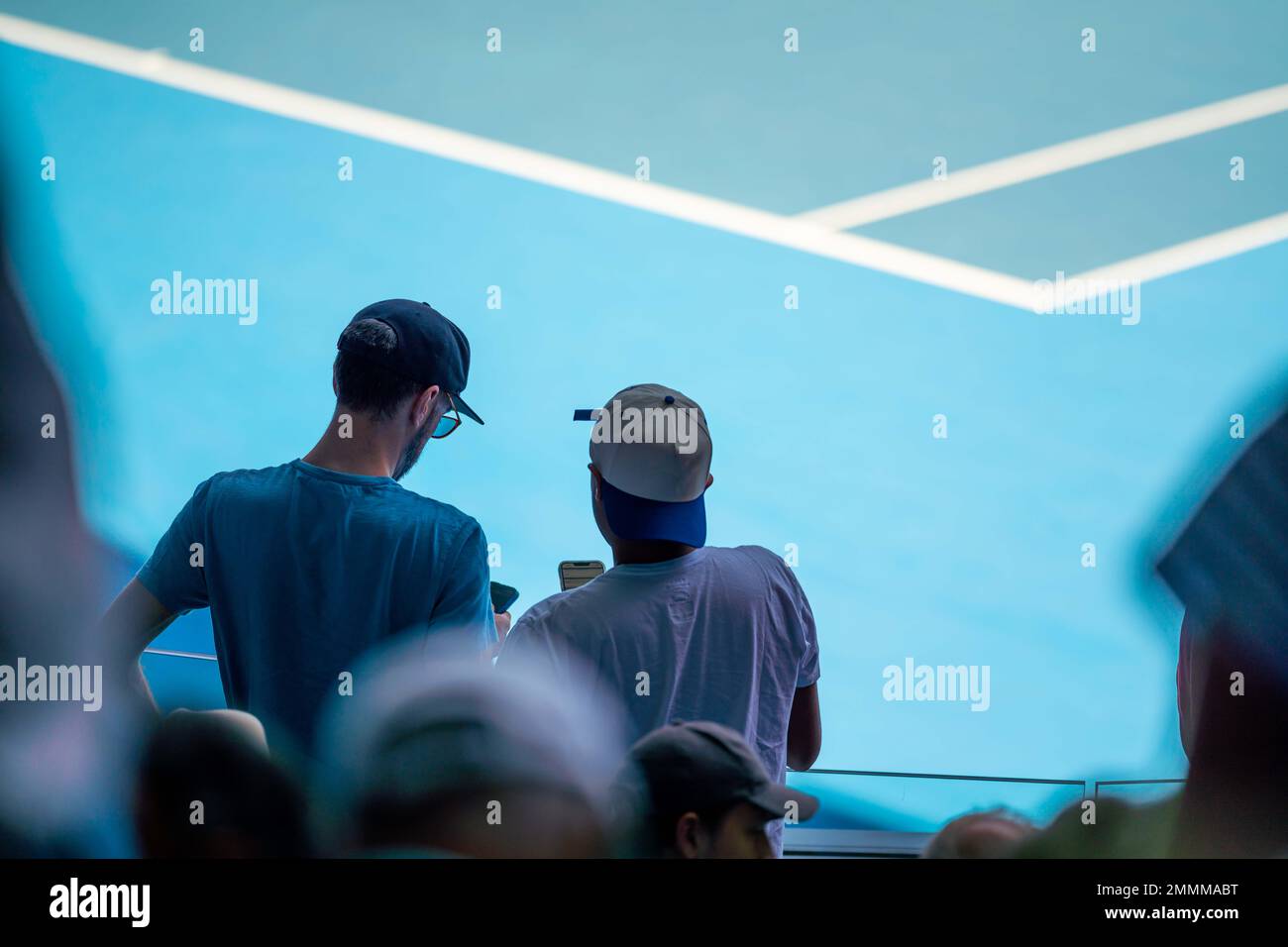 tennis fan watching a tennis match at the australian open eating food ...