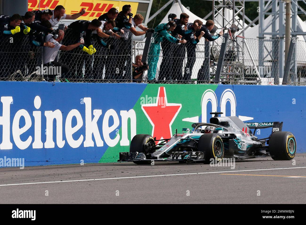 Mercedes team members cheer at Mercedes driver Lewis Hamilton of ...