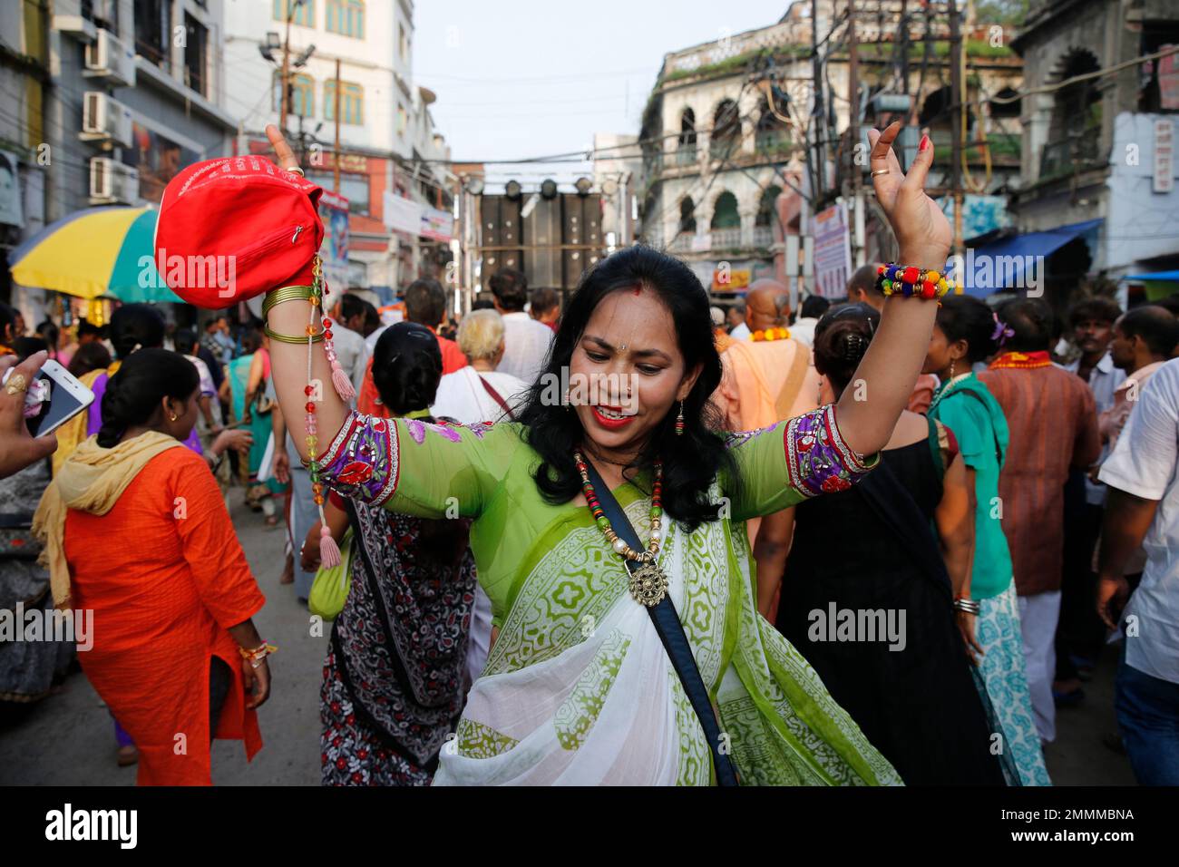 Hindu devotees dance and sing in a procession as part of celebrations ...